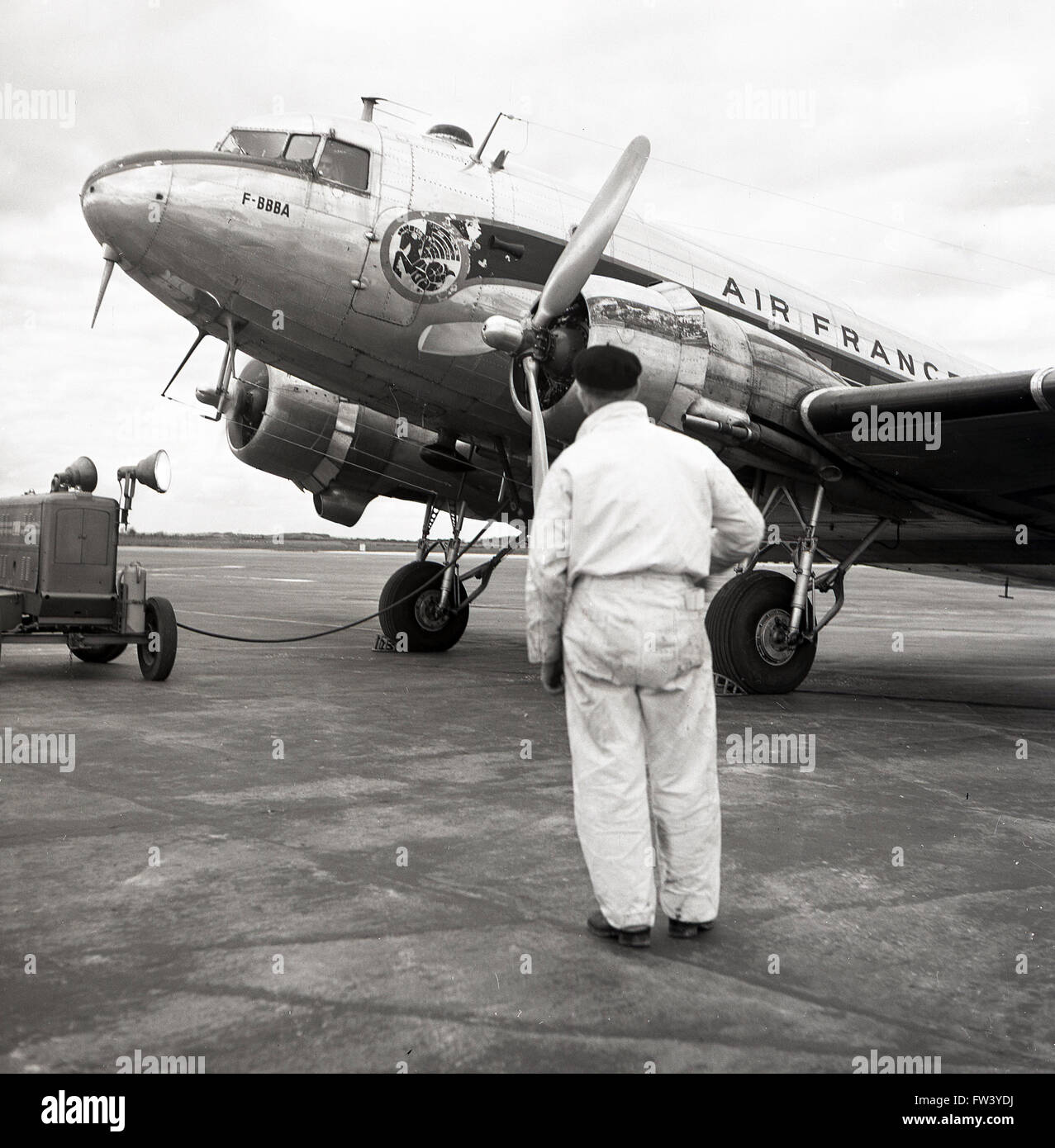 1950s historical, Air France plane being refueled on runway, supervised ...