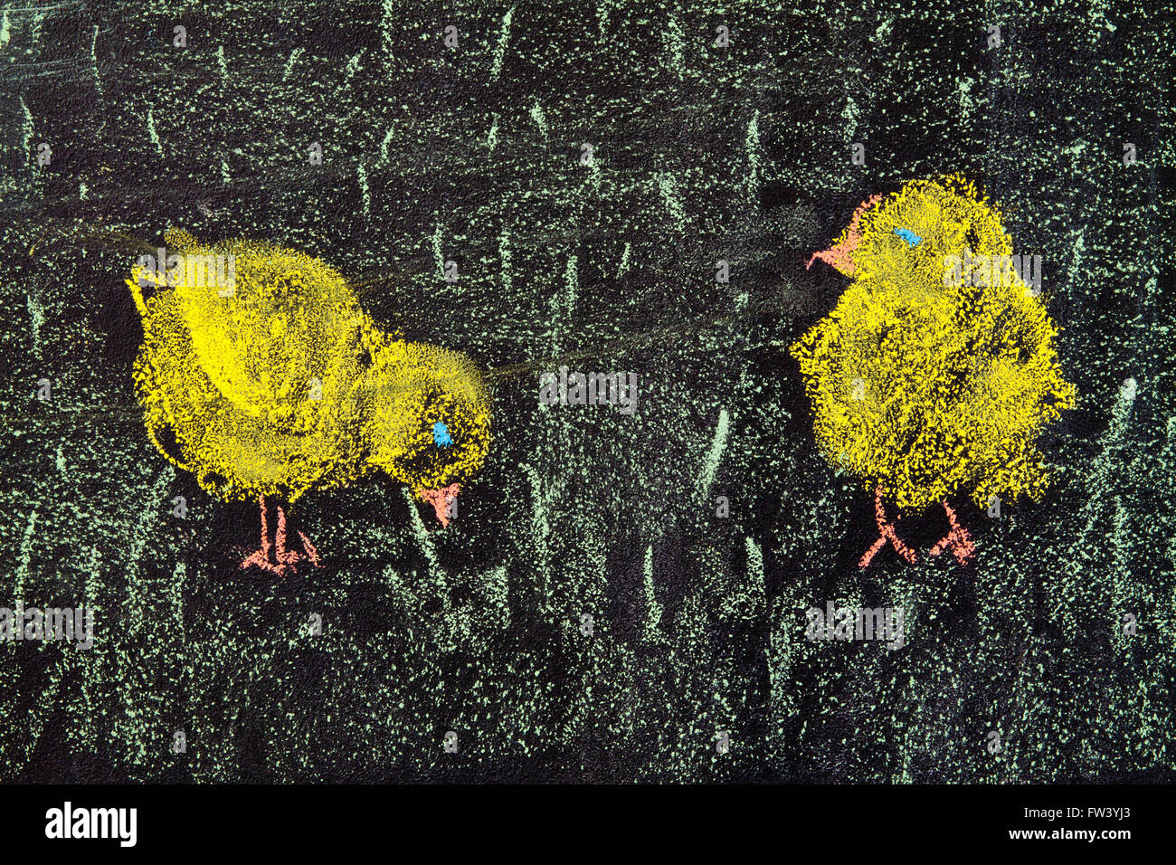two small yellow chickens on a green grass Stock Photo - Alamy