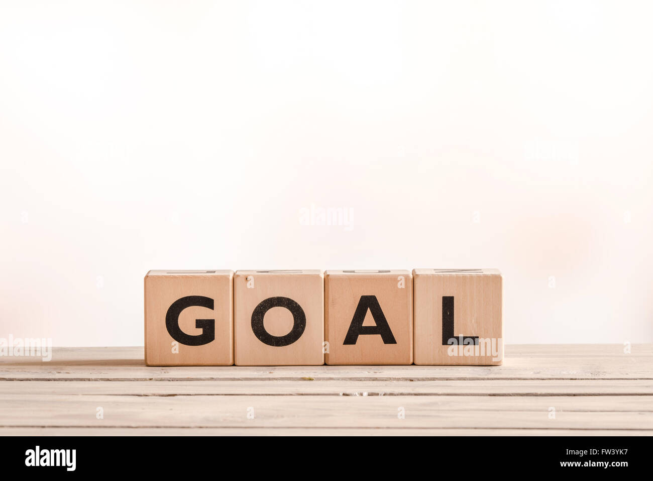 Goal sign made of cubes on a wooden office desk Stock Photo - Alamy