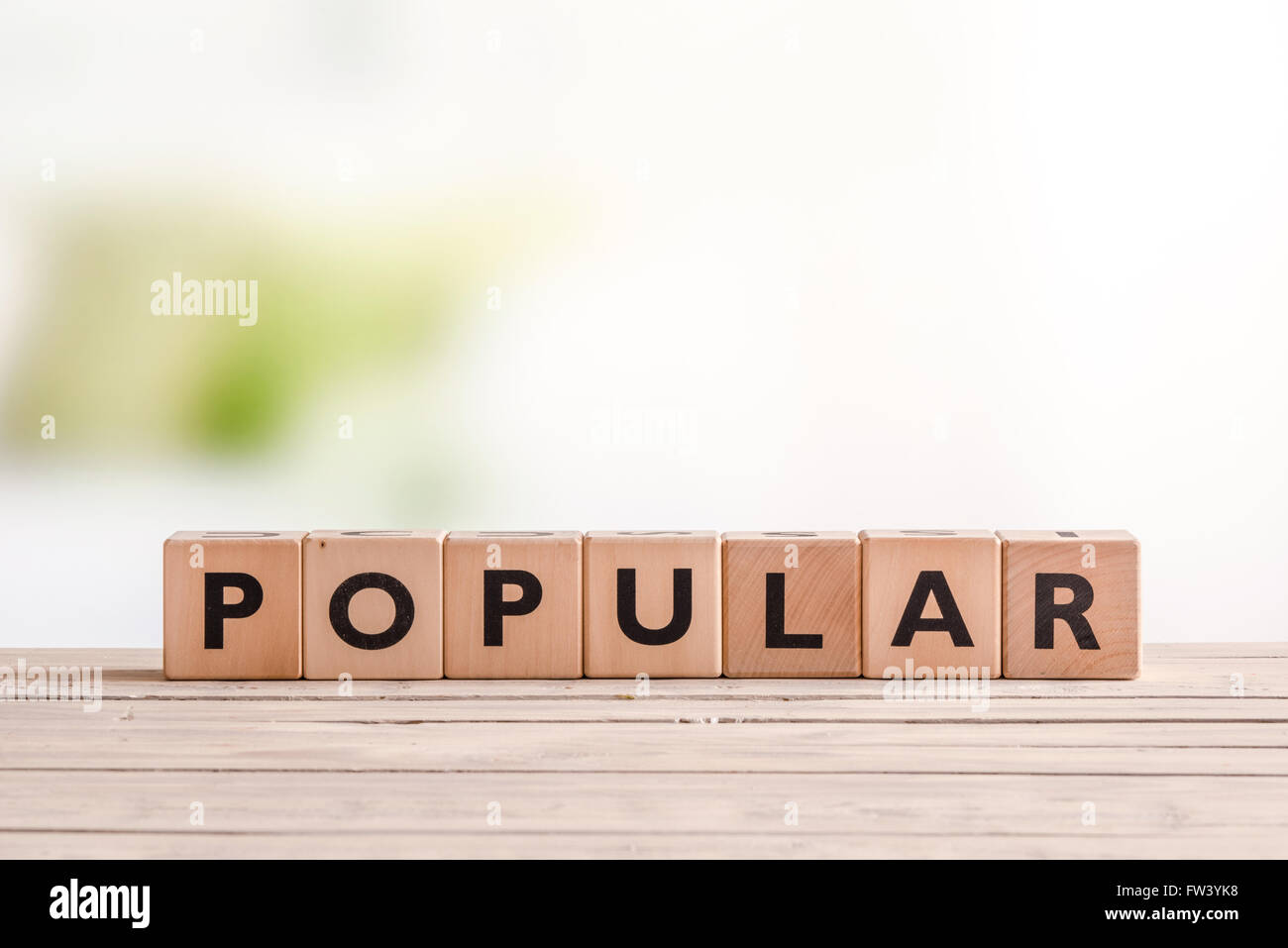 Popular sign made of cubes on a table with planks Stock Photo - Alamy
