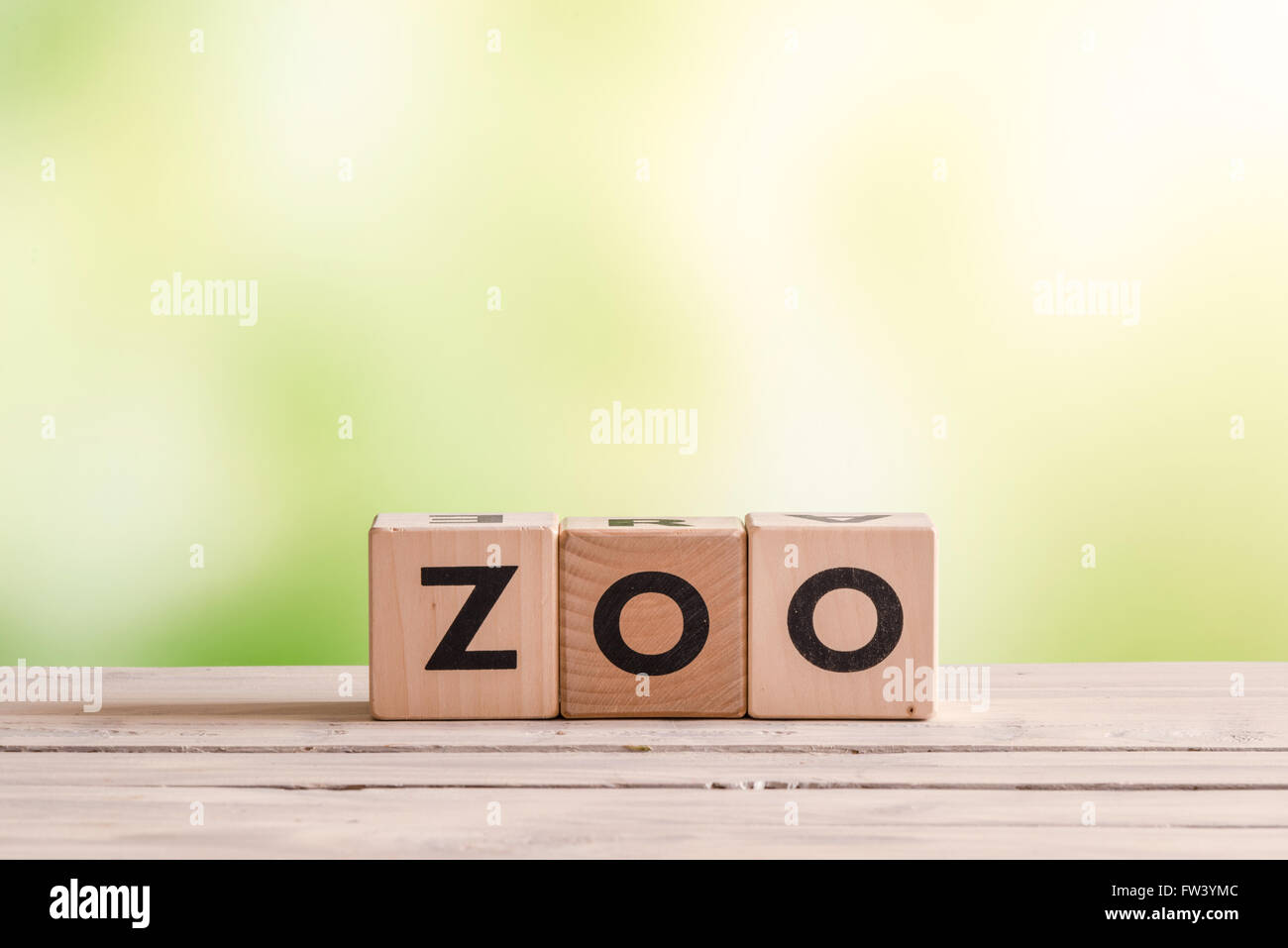 Zoo sign made of wood on a green background Stock Photo - Alamy