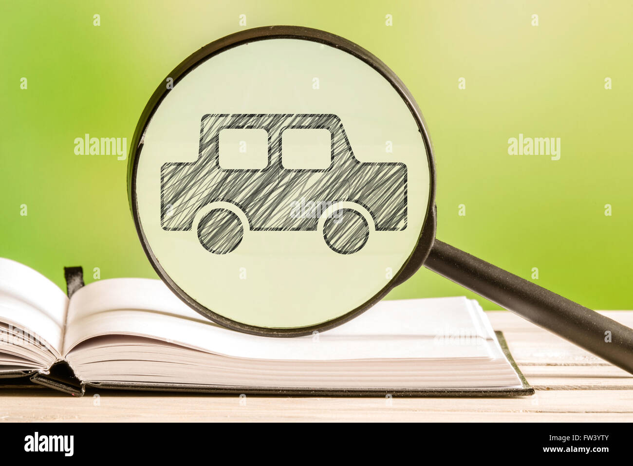Car search with a pencil drawing of an automobile in a magnifying glass ...