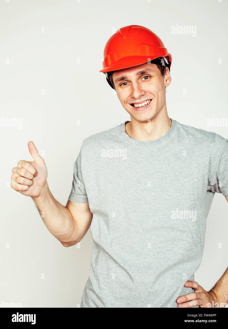 young real hard worker man isolated on white background on ladder ...