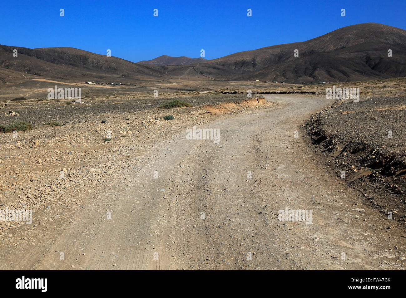 Dirt road crossing dry barren mountain landscape near Paraja ...