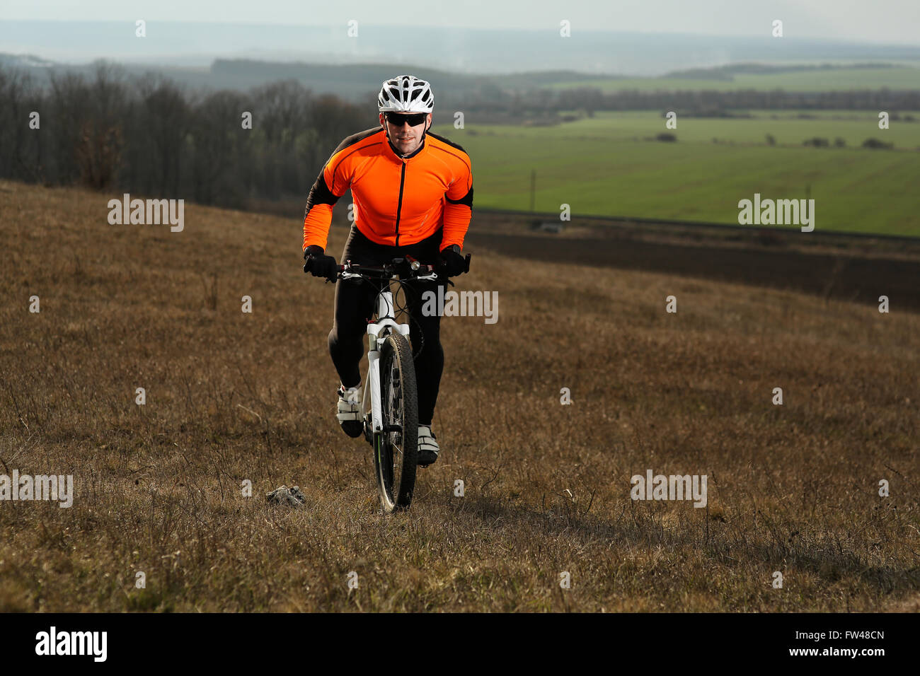 Man cyclist with backpack riding the bicycle Stock Photo - Alamy