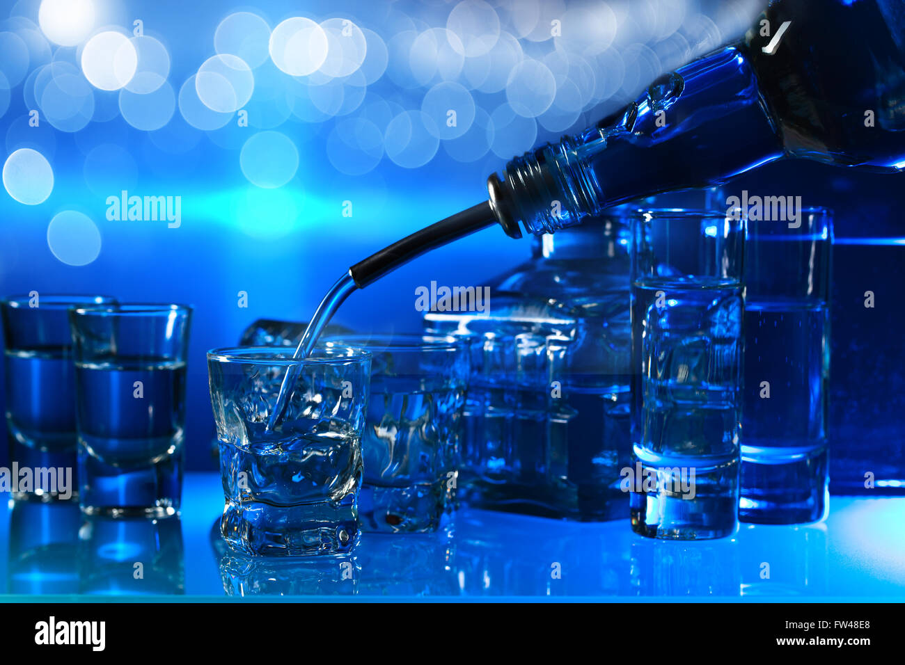 vodka in bar on a glass table Stock Photo - Alamy