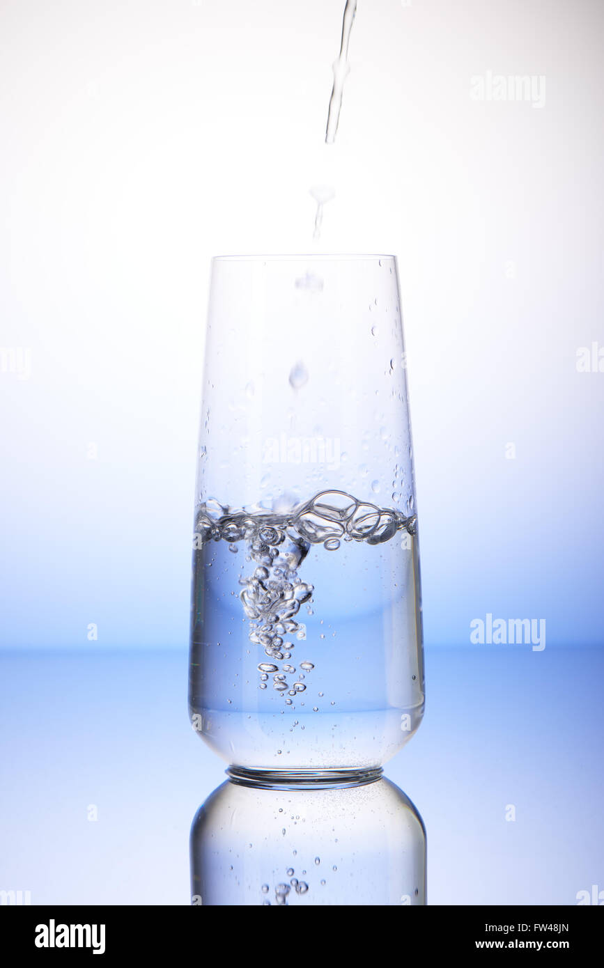Half filled water glass on white hi-res stock photography and images ...