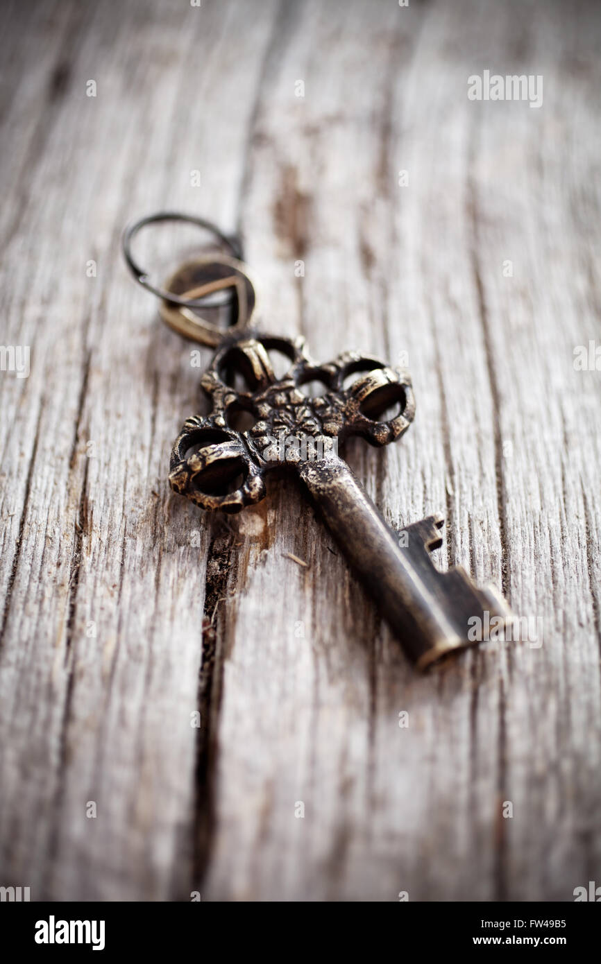 Old rustic key on wooden background Stock Photo - Alamy