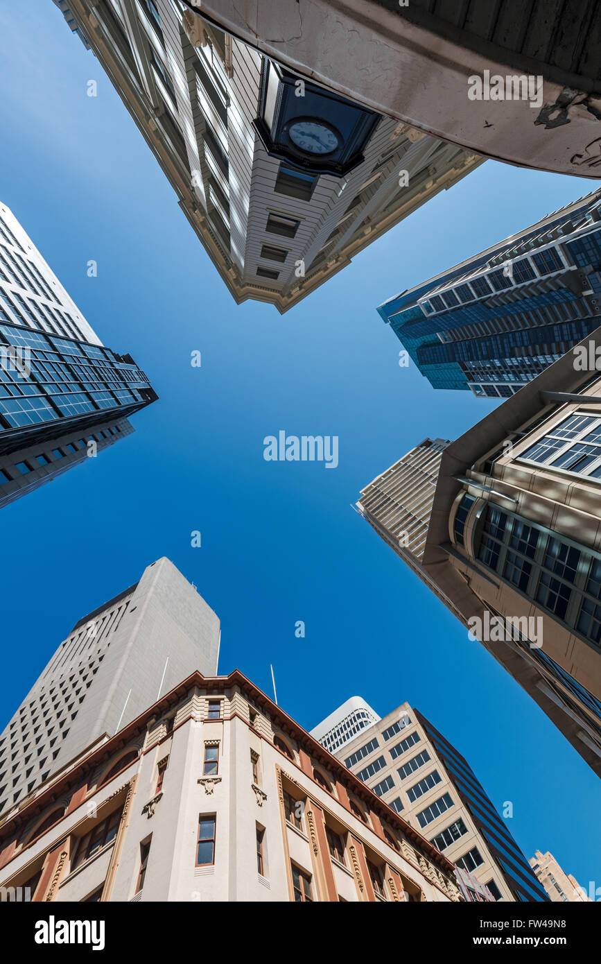 Five tall buildings viewed from bottom looking up with blue sky during ...