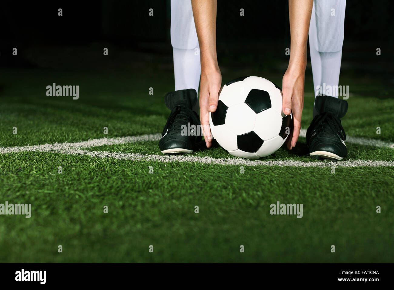 Athlete placing soccer ball for corner kick Stock Photo - Alamy