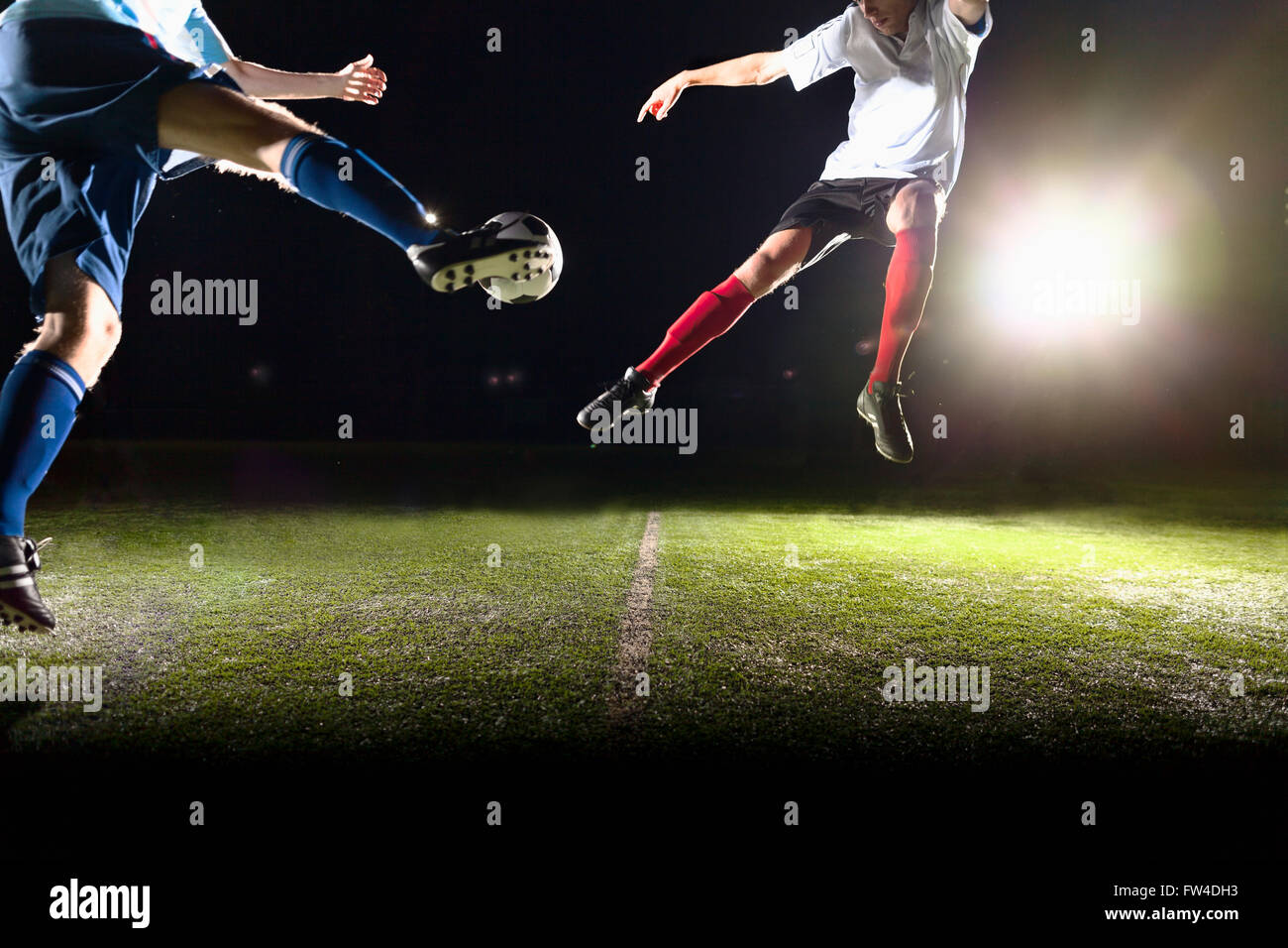 Two soccer players kicking a soccer ball Stock Photo - Alamy