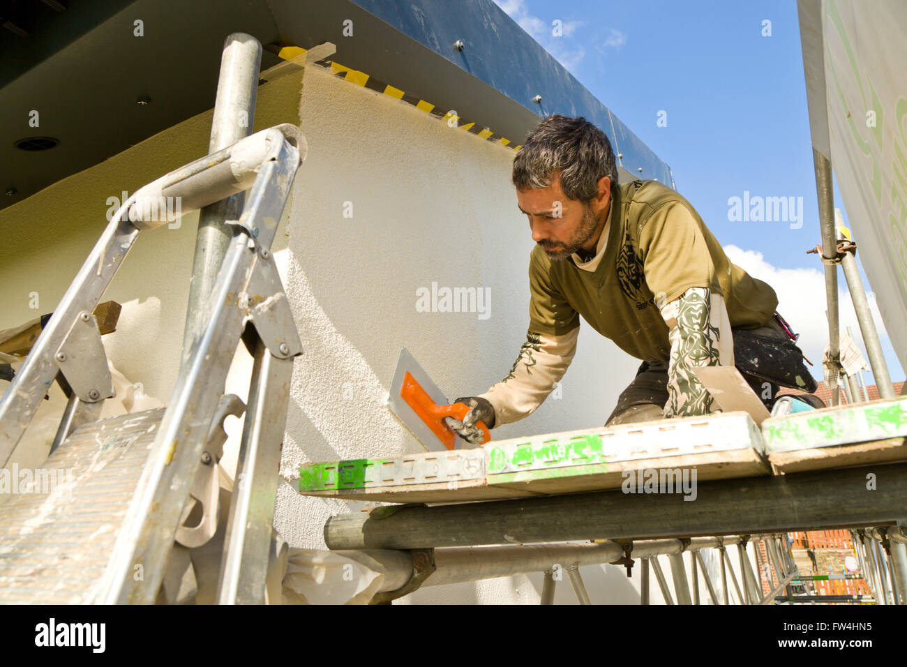 Builder rendering the gable end of a house Stock Photo - Alamy
