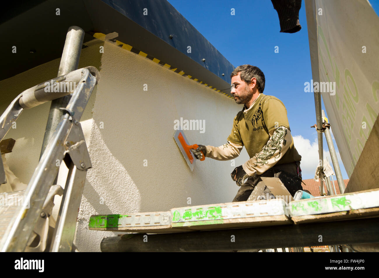 Builder rendering the gable end of a house Stock Photo - Alamy