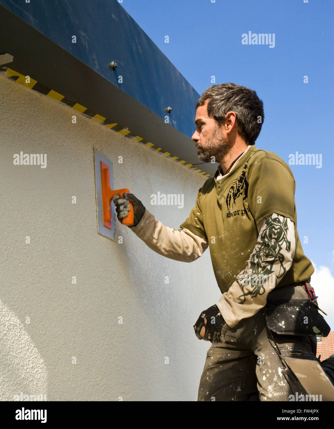Builder rendering the gable end of a house Stock Photo - Alamy