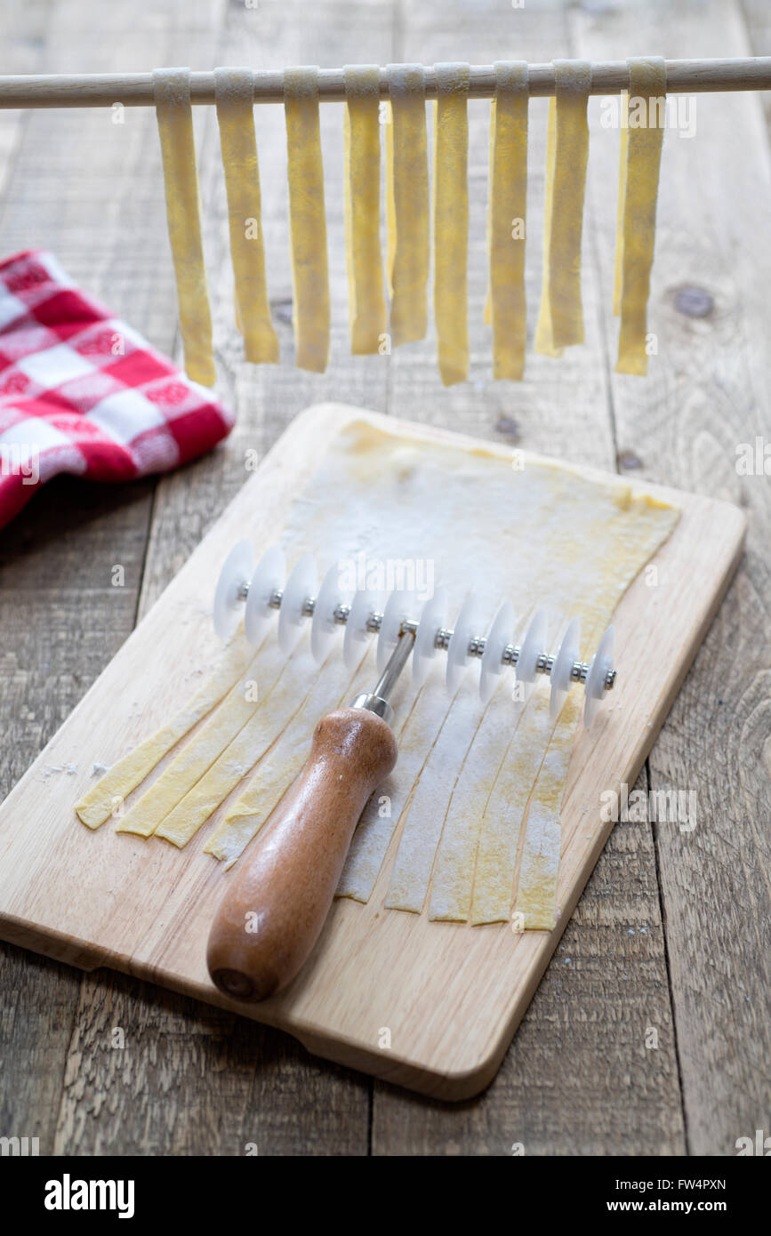 Making homemade tagliatelle pasta - cutting and drying the pasta Stock ...