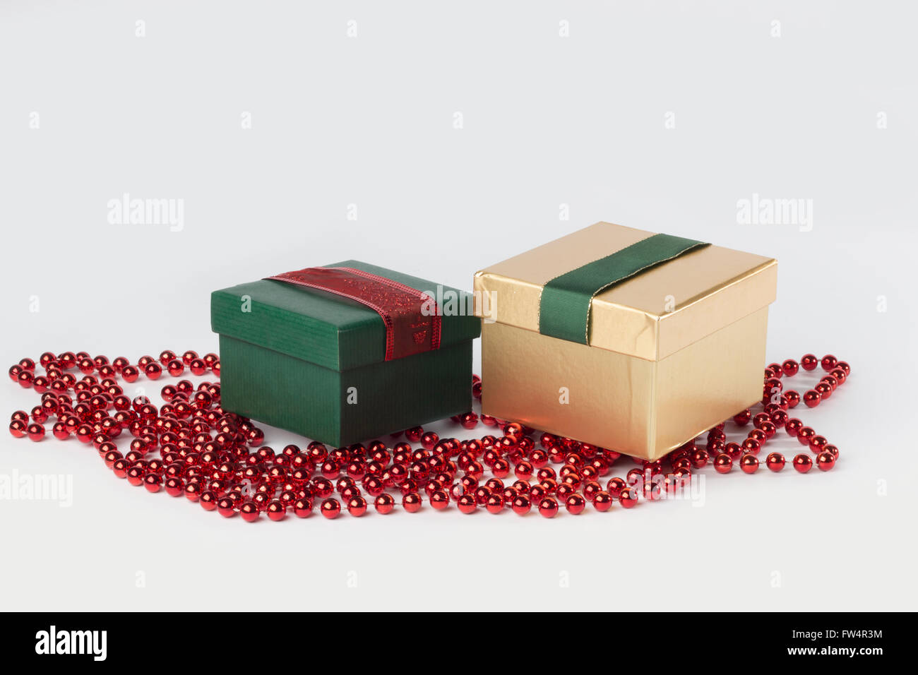 Two presents, green and gold, with ribbons, isolated on white ...