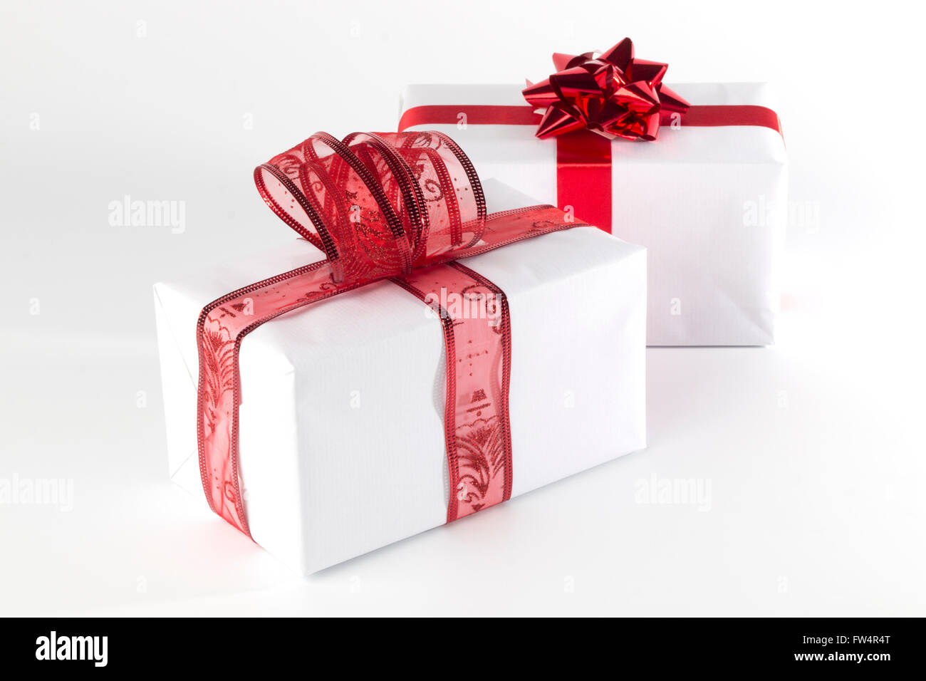 White presents with red ribbons and bows, isolated on white background ...