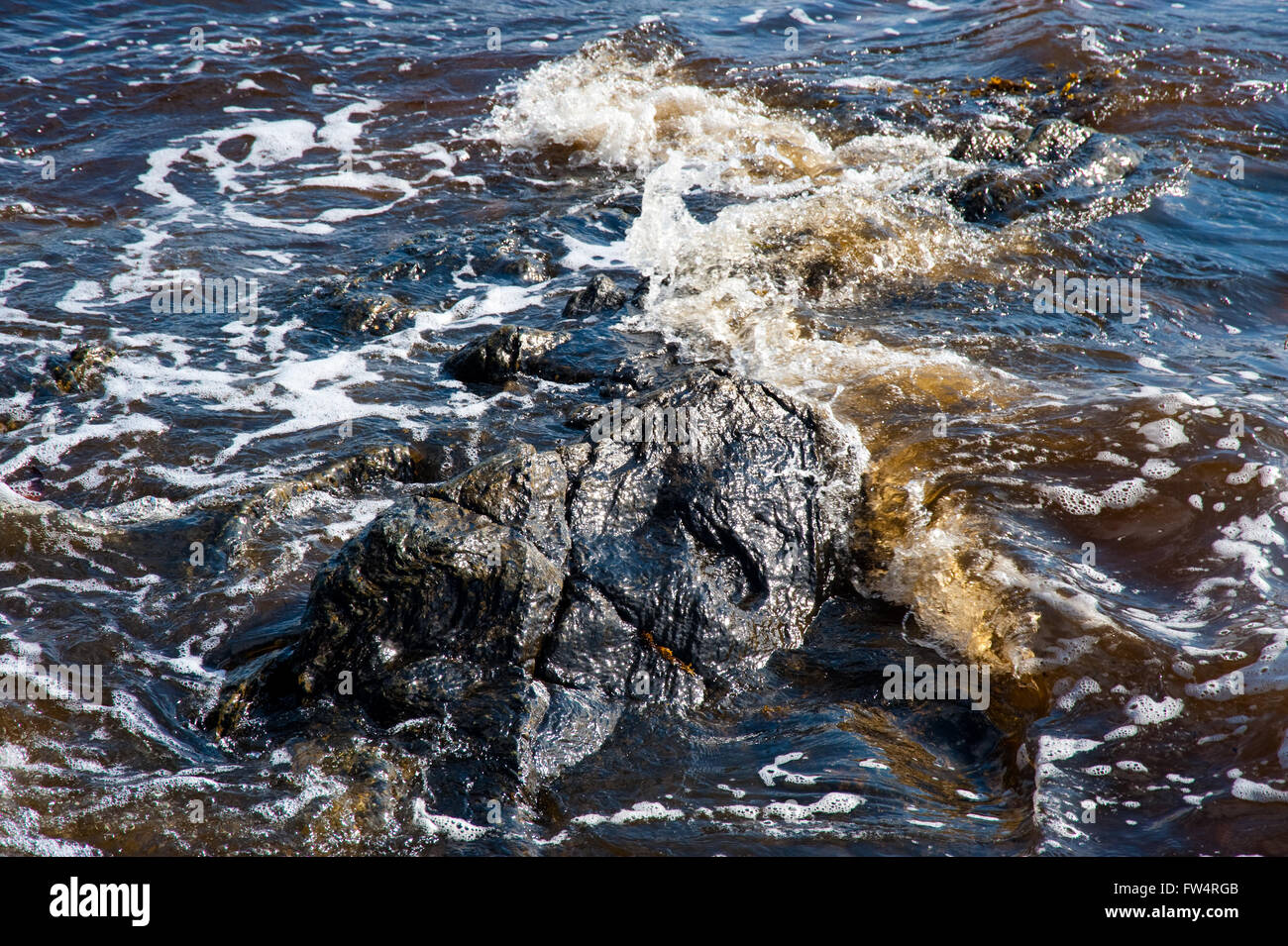 Water covered rocks in highland loch Stock Photo - Alamy