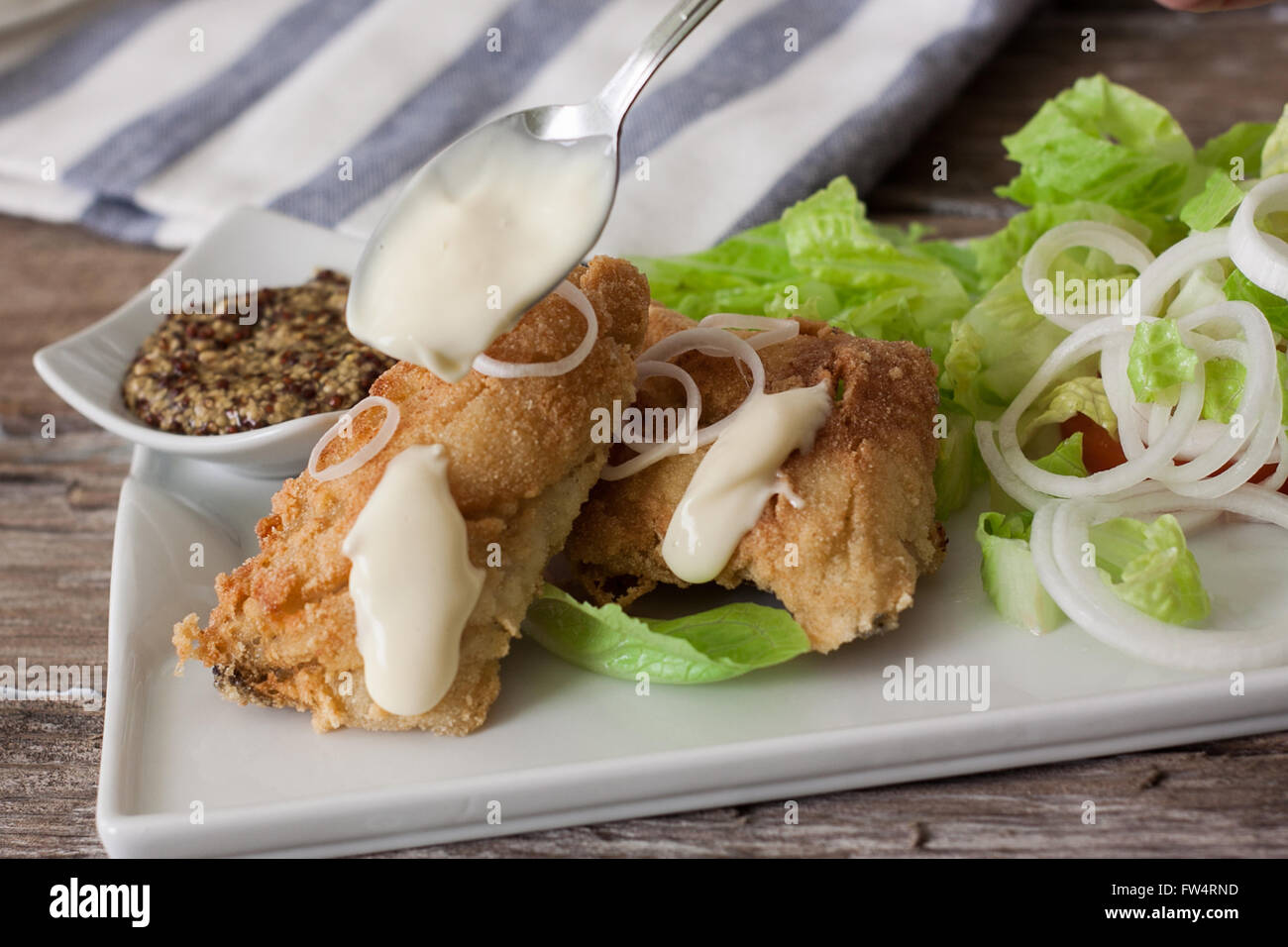 deep fried cod fish with salad mayonnaise and mustard Stock Photo - Alamy