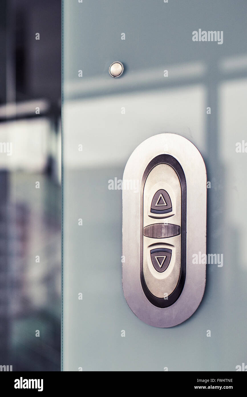 Elevator button. On modern glass wall Stock Photo - Alamy