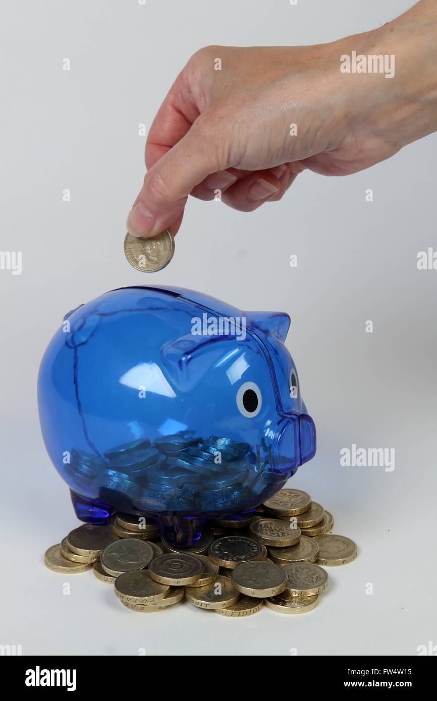 Money being saved in piggy bank Stock Photo - Alamy
