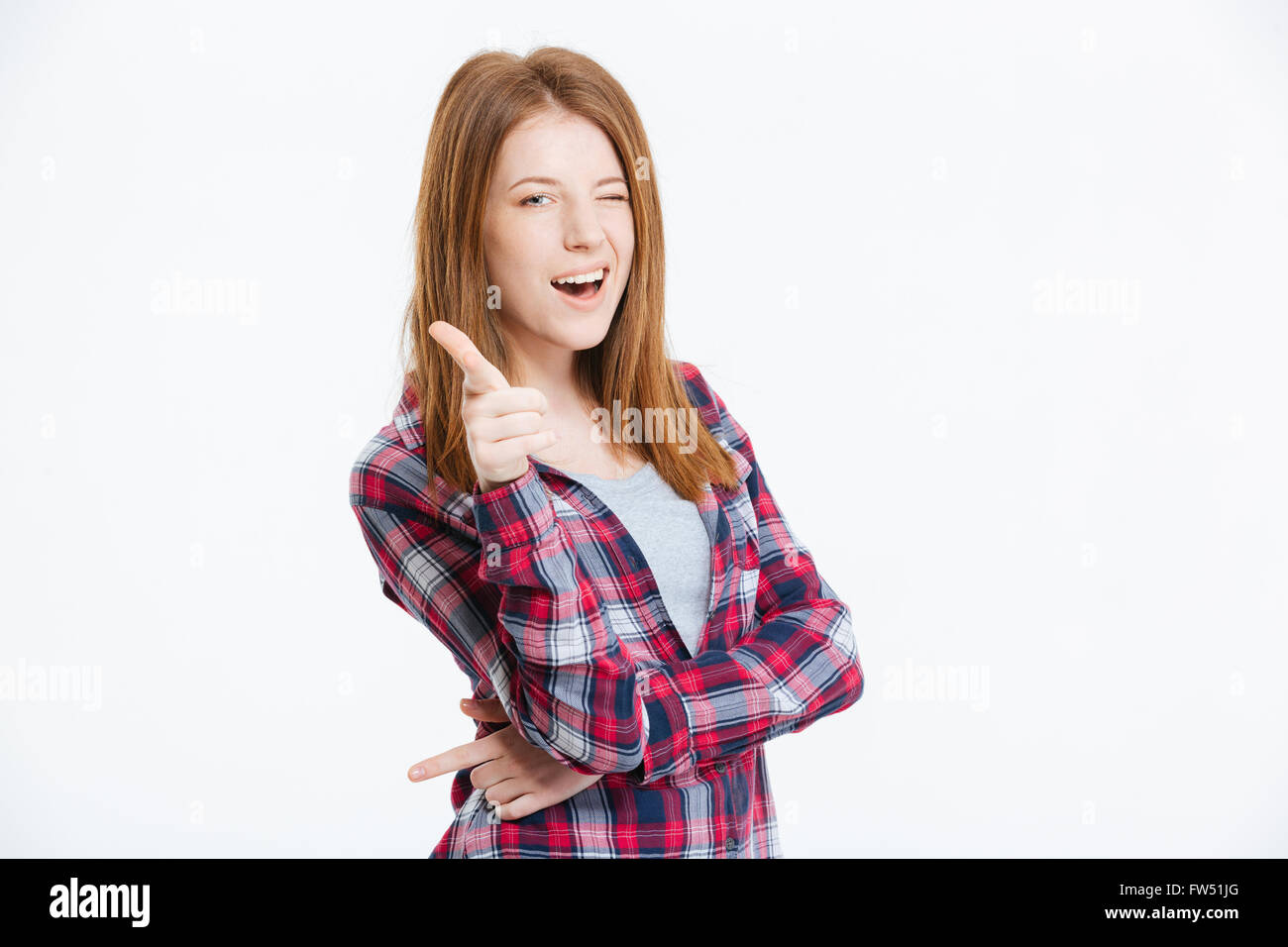 Happy woman showing finger at you and winking isolated on a white ...