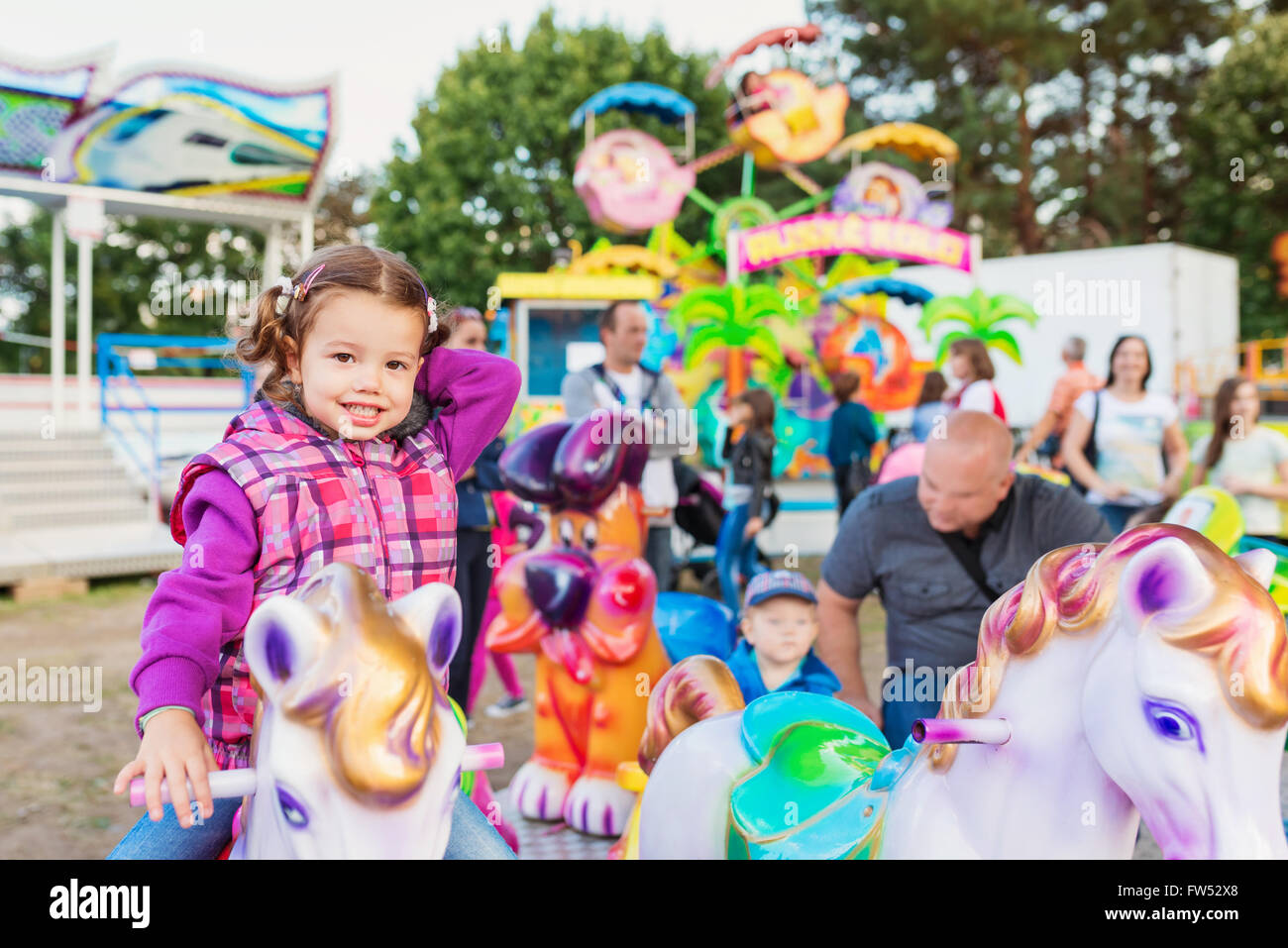 Little girl enjoying ride at fun fair, amusement park Stock Photo - Alamy