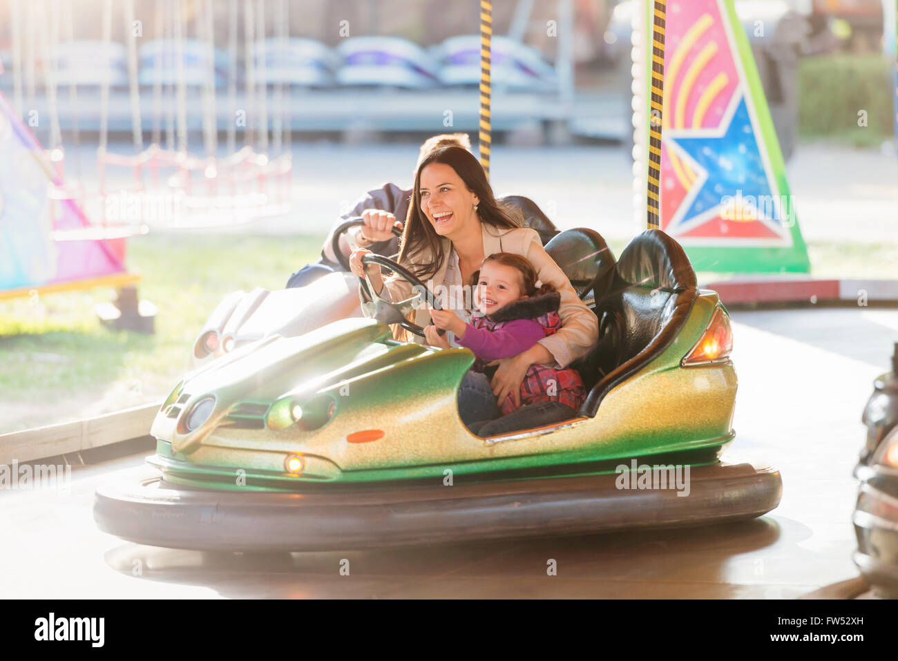 Mother and daughter in bumper car at fun fair Stock Photo - Alamy