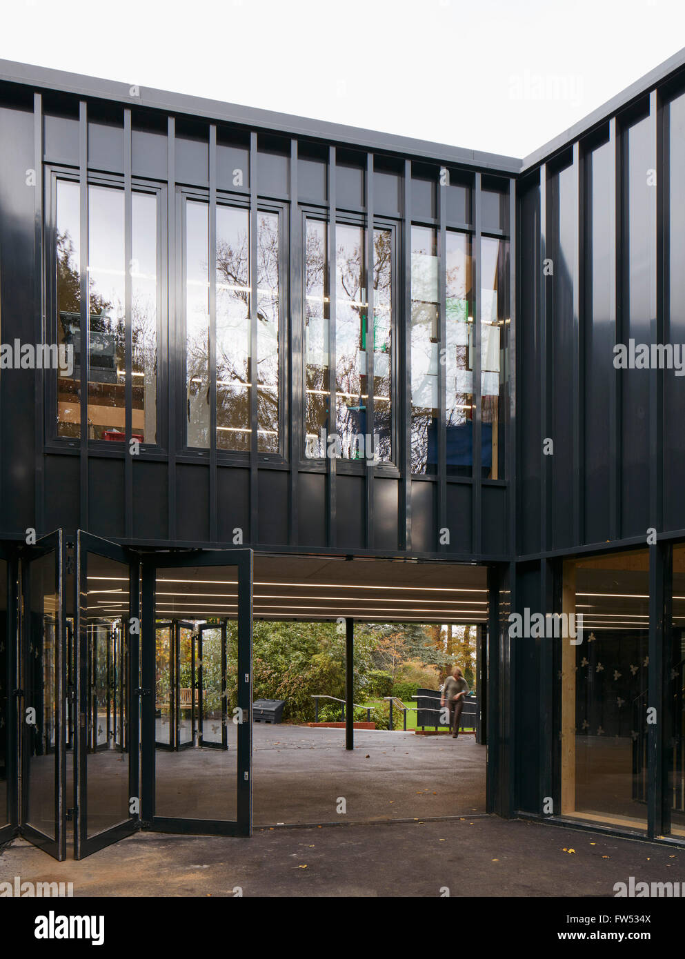 Building passage with open doors connecting garden and play area ...
