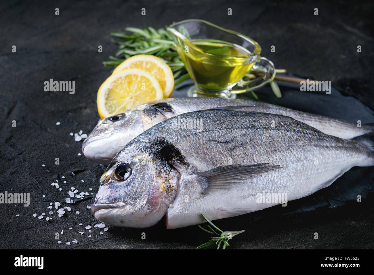 Raw bream fish with herbs Stock Photo - Alamy