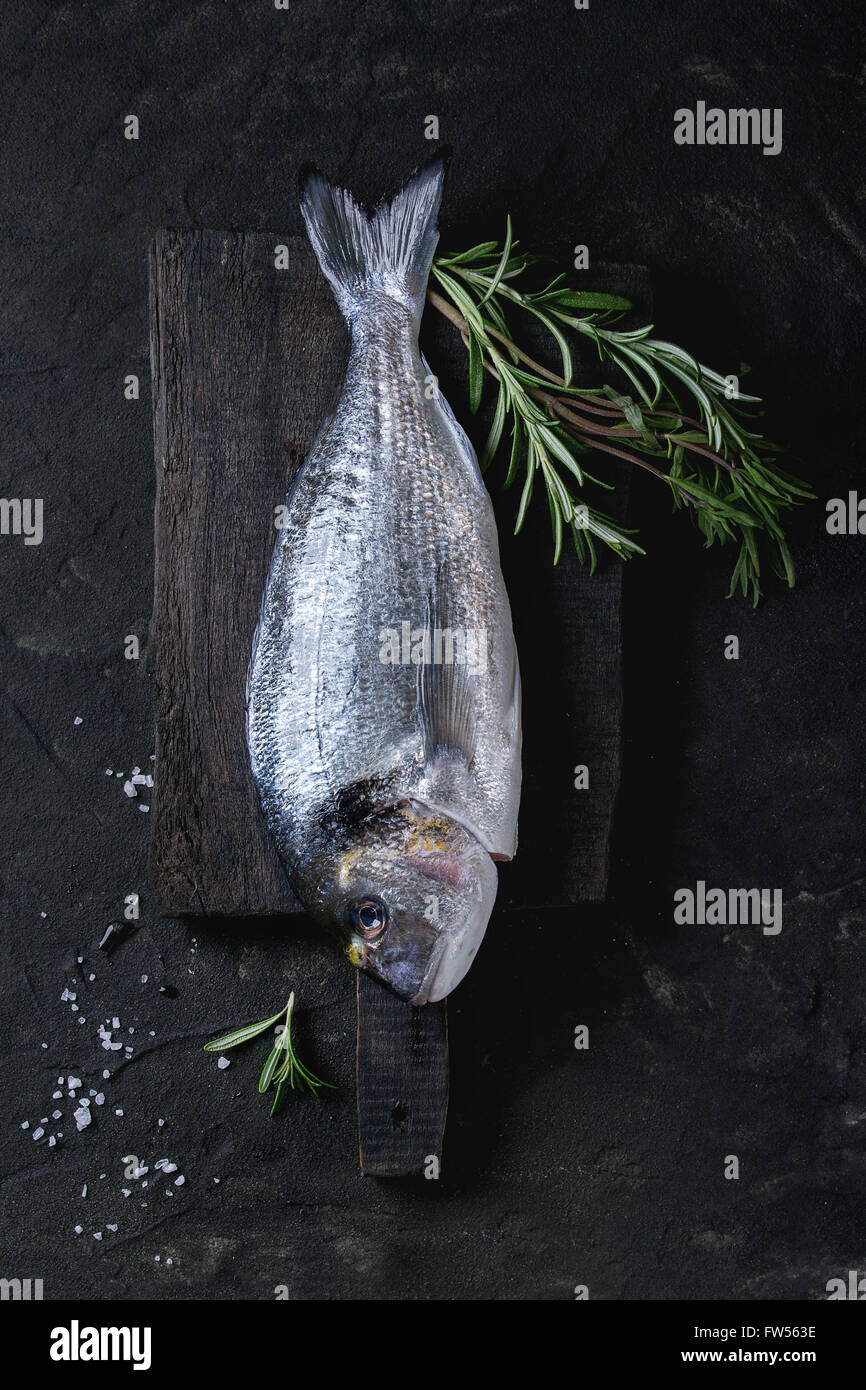 Raw bream fish with herbs Stock Photo - Alamy