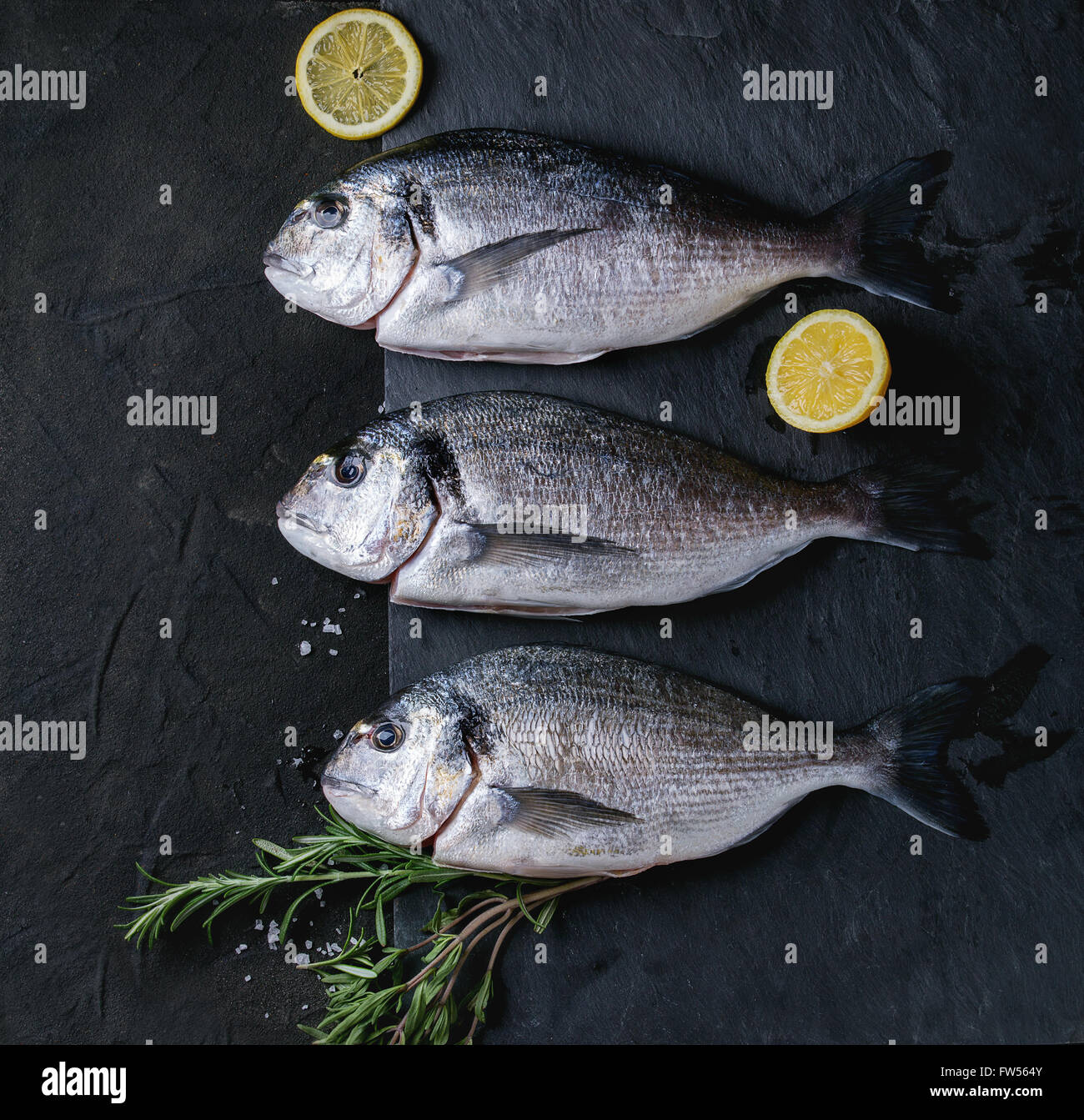 Raw bream fish with herbs Stock Photo - Alamy
