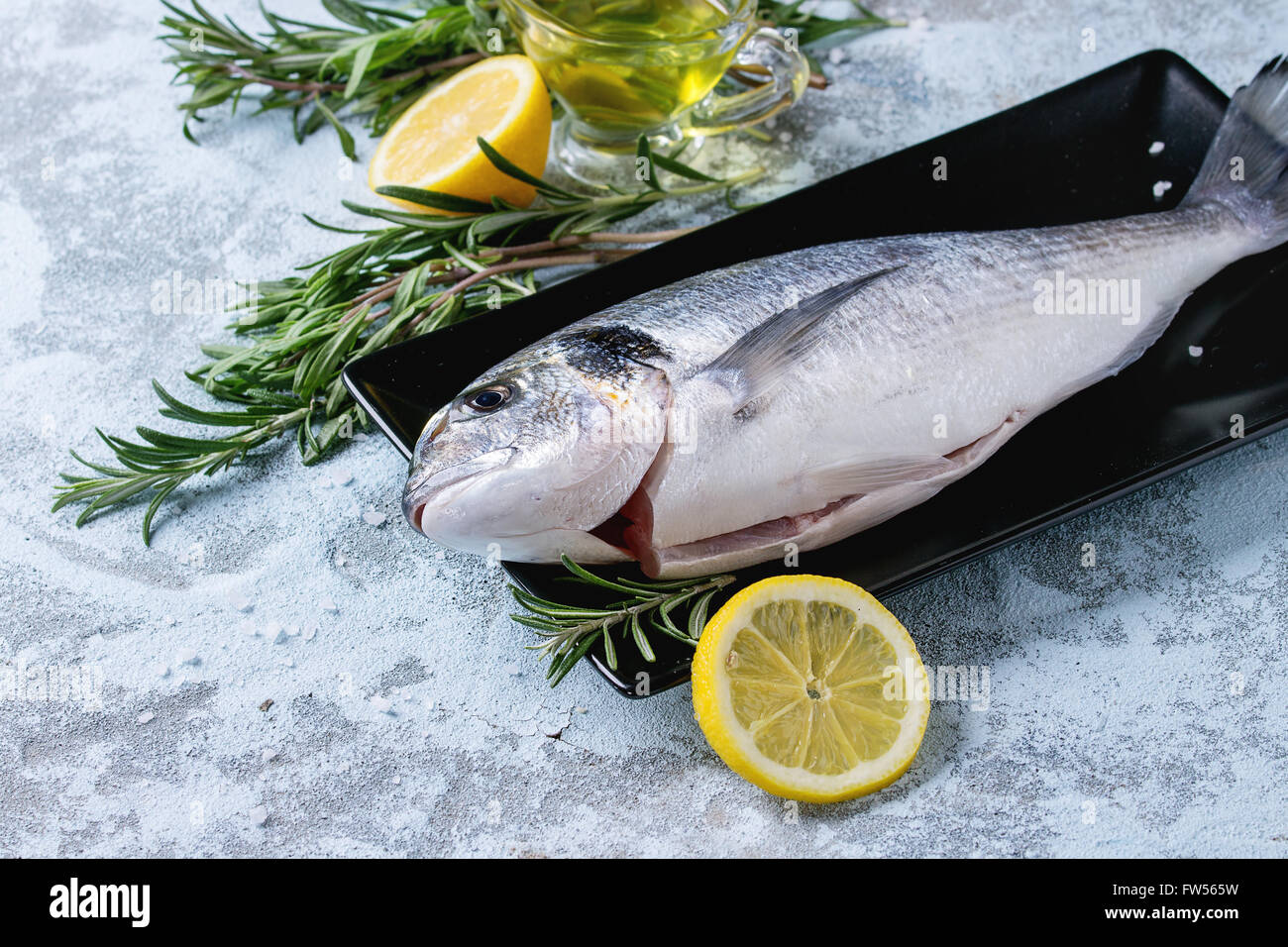 Raw bream fish with herbs Stock Photo - Alamy