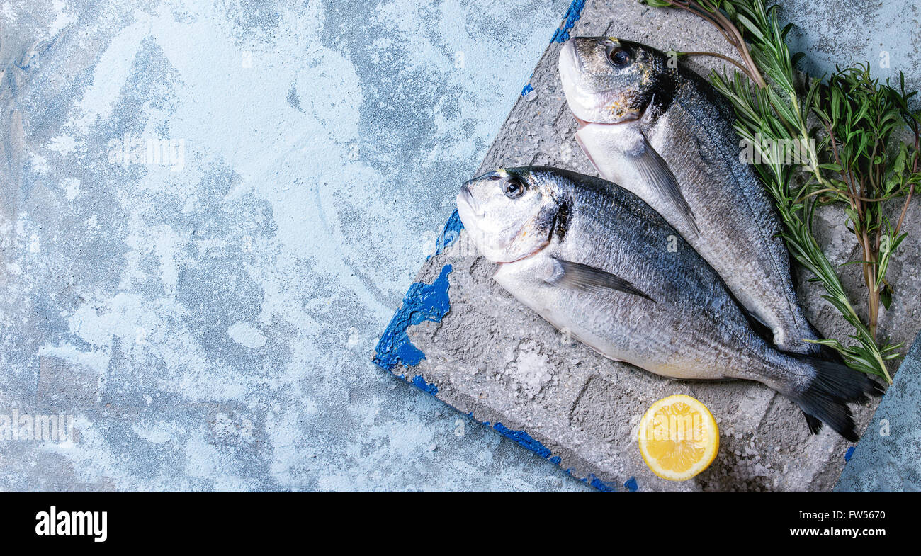 Raw bream fish with herbs Stock Photo - Alamy