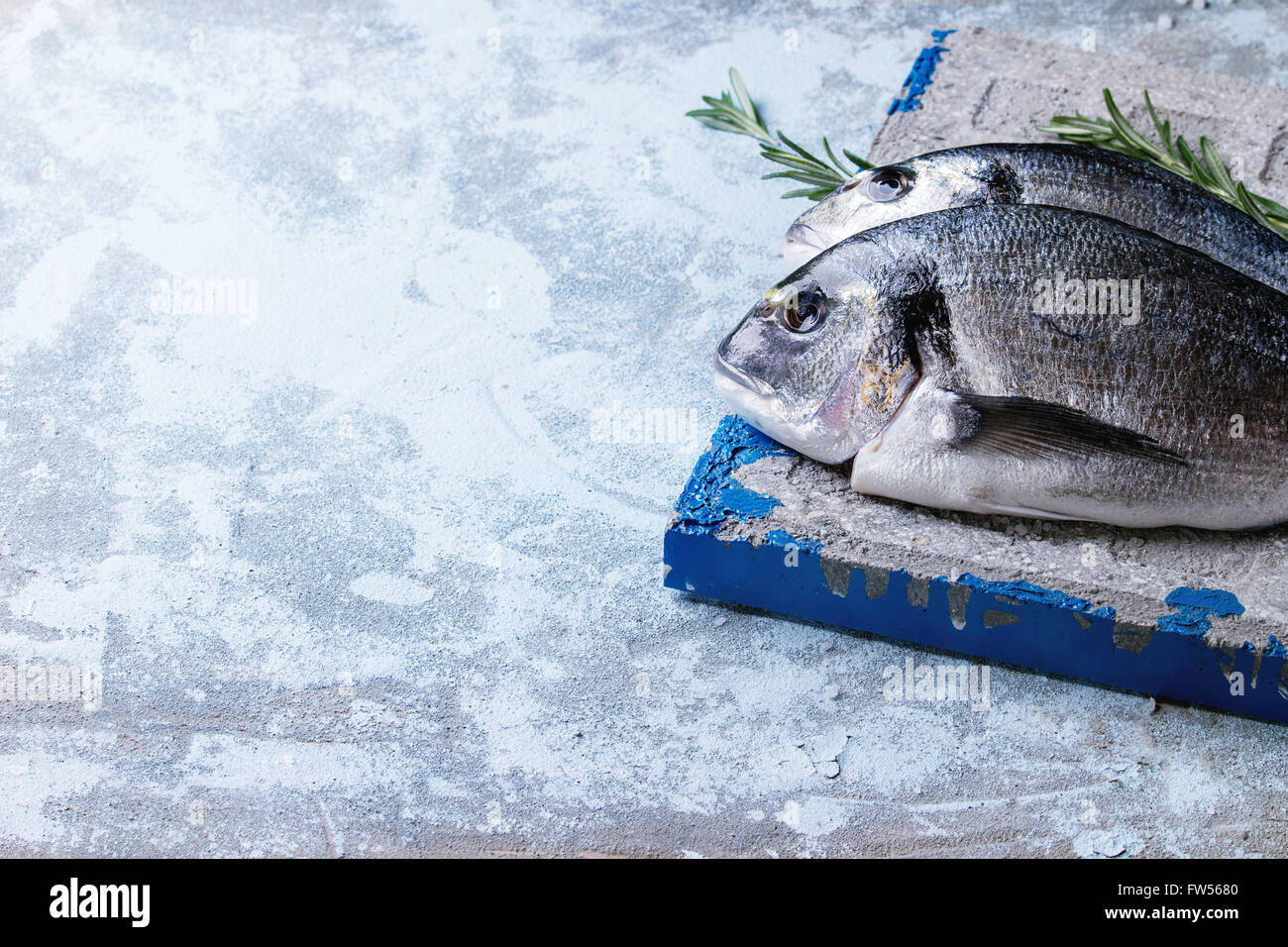 Raw bream fish with herbs Stock Photo - Alamy