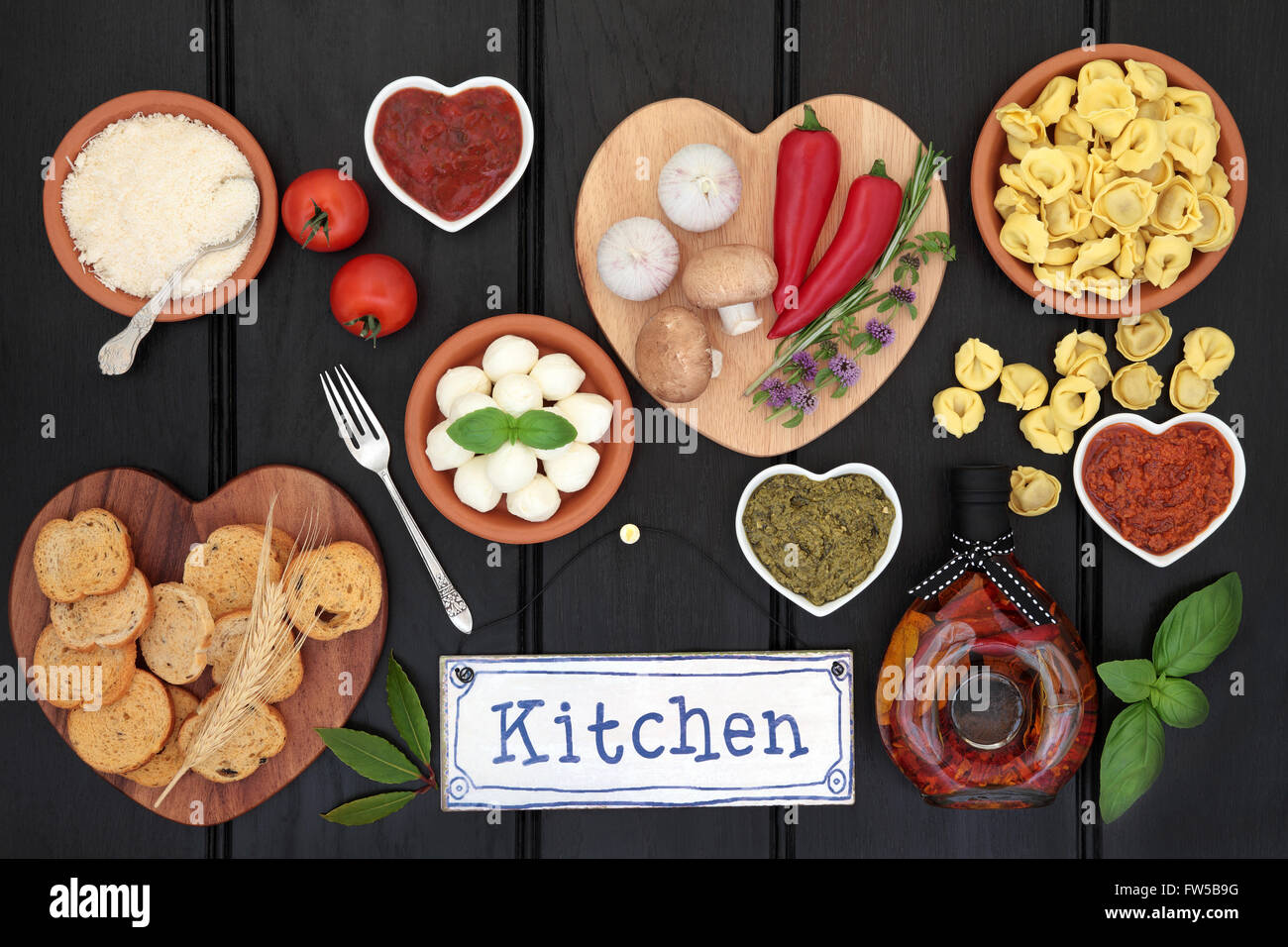 Italian food ingredient selection with old metal kitchen sign over dark ...