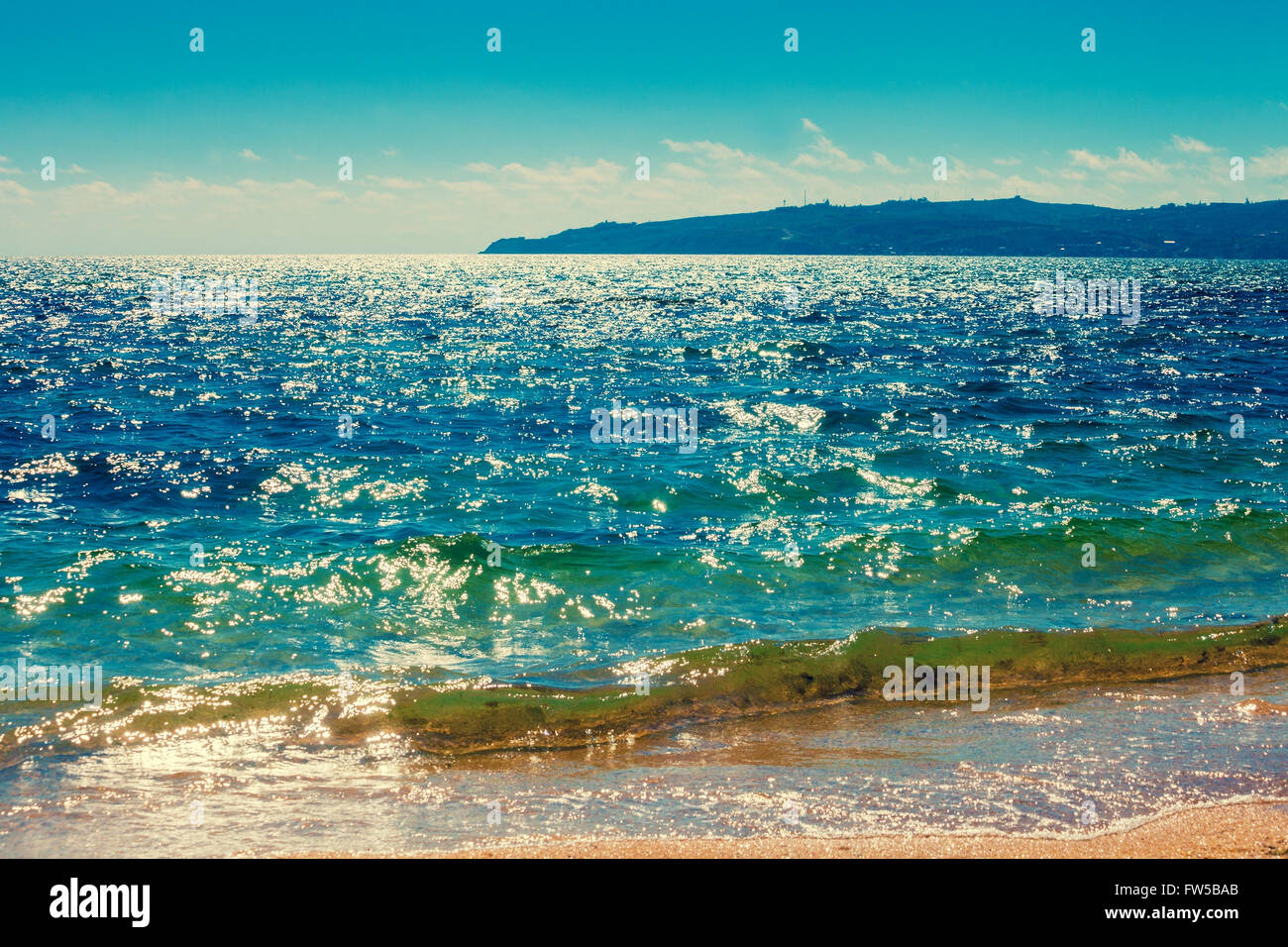 Sparkling sea water in bright sunlight on the seashore Stock Photo - Alamy