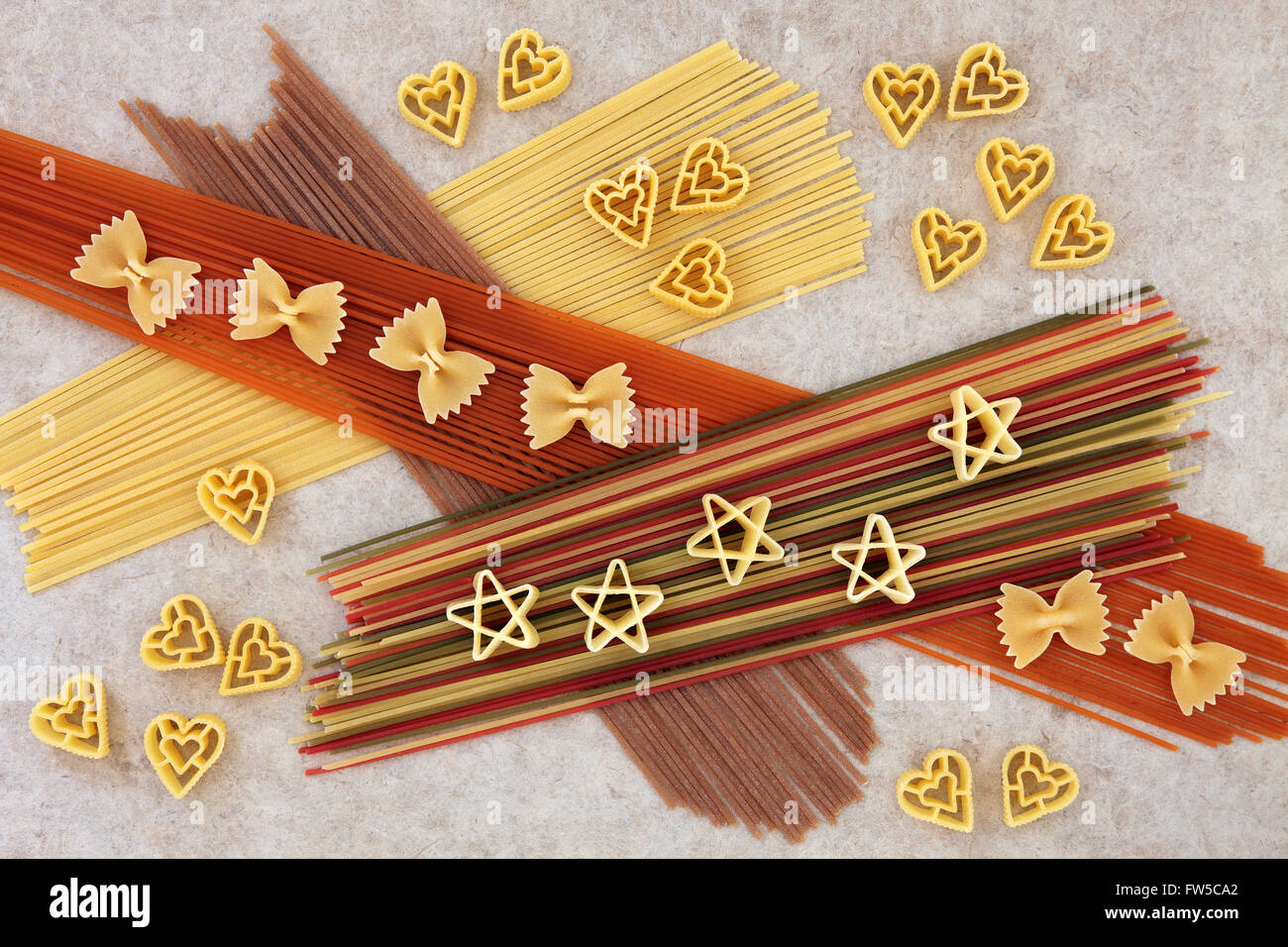 Dried pasta spaghetti food abstract background over natural hemp paper ...