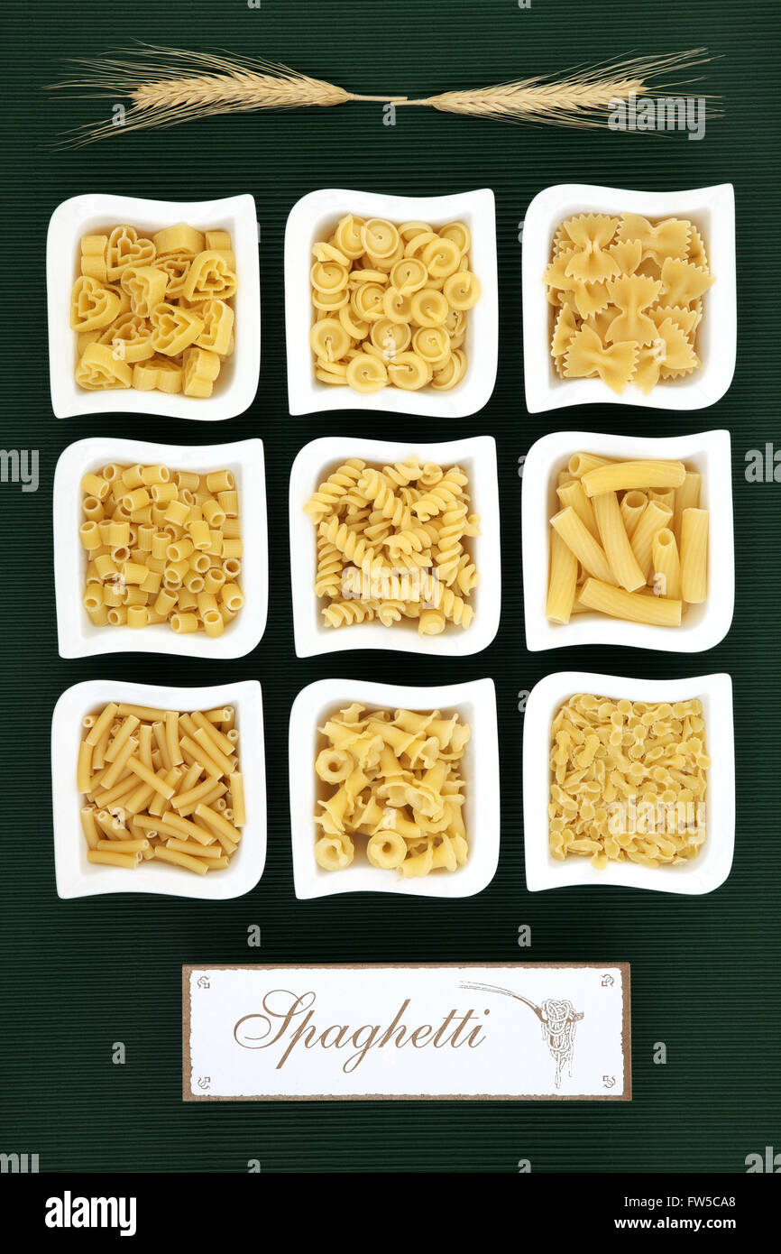 Italian dried food pasta selection with old wooden sign over ridged ...