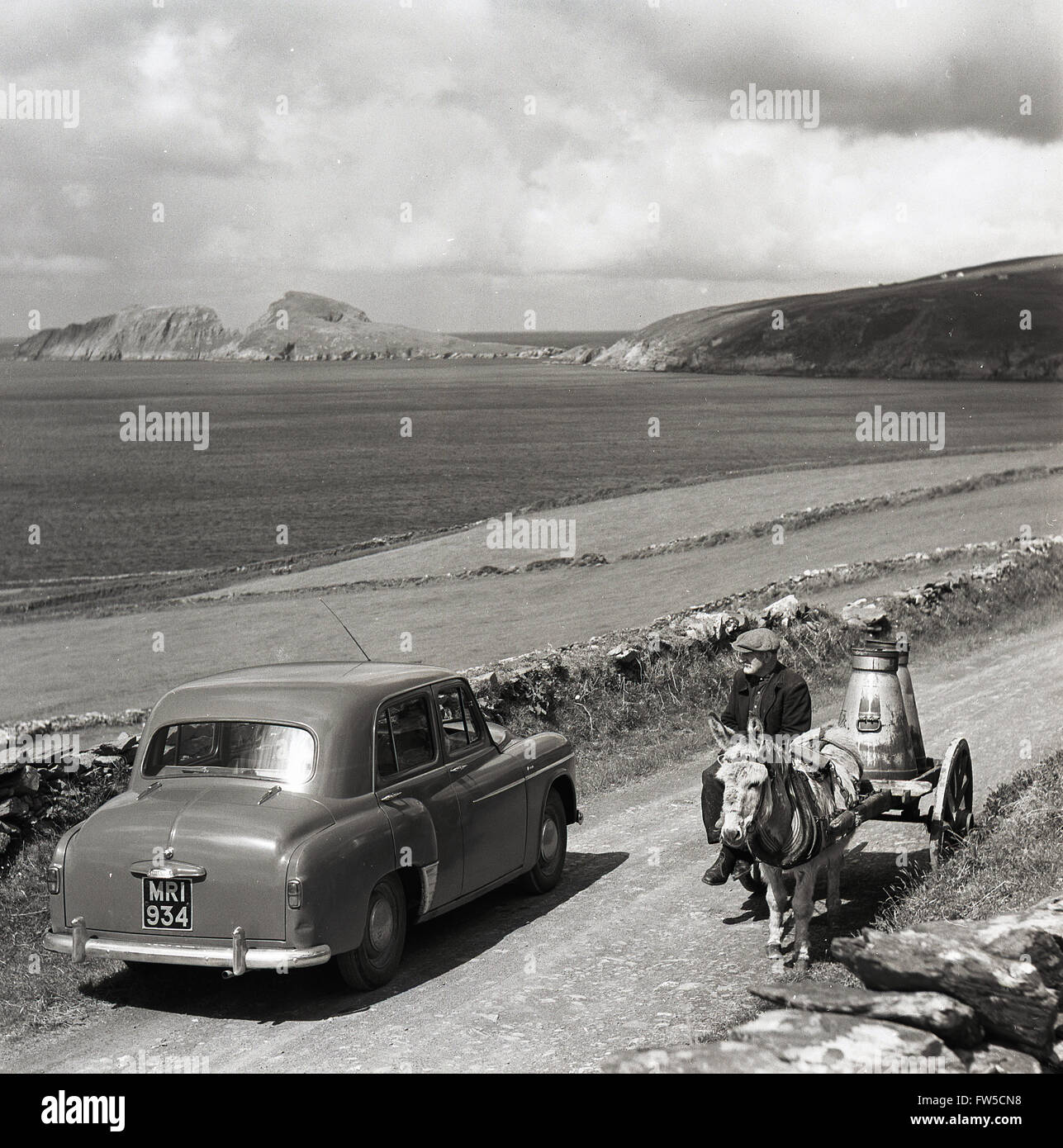 1950s historical picture, west of Ireland, car stops on lane to talk to ...