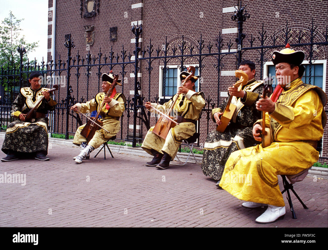 Mongolian musicians busking in Amsterdam. Playing string instruments ...