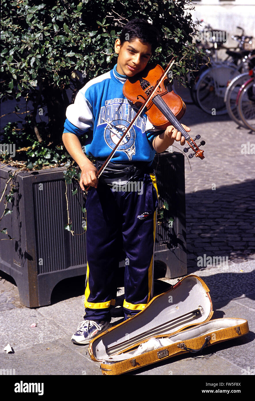 Boy playing violin busking in the streets of Parma Italy Stock Photo ...