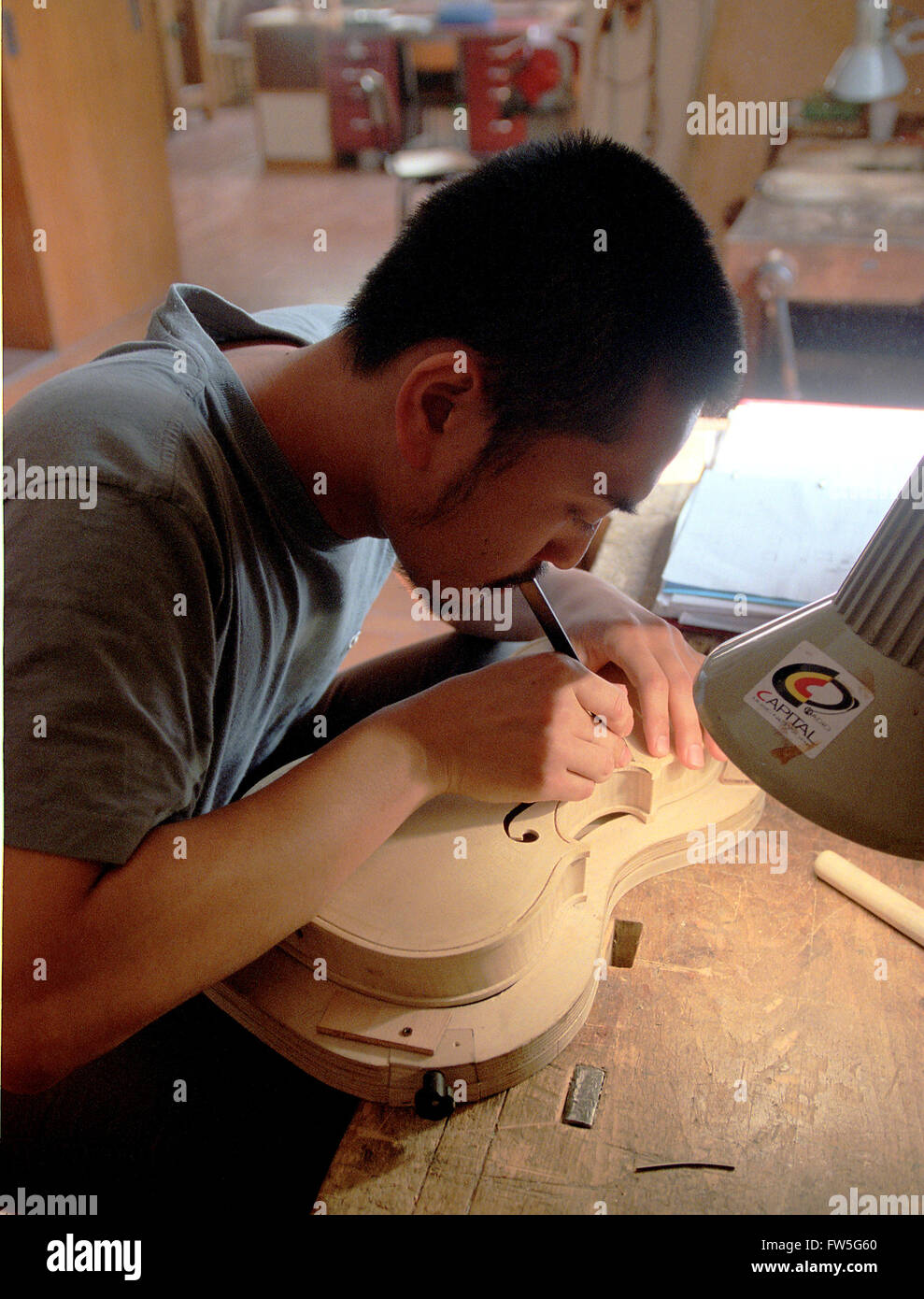 Violin maker 's workshop - a student carving violin recess for inlay at ...