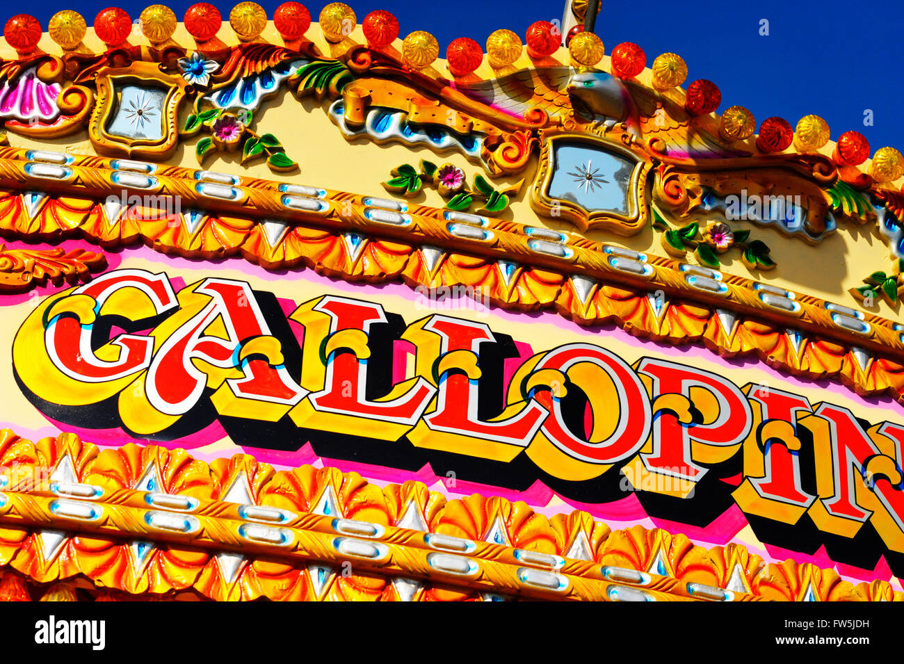 galloping': brightly painted fairground merry-go-round, merry go round ...