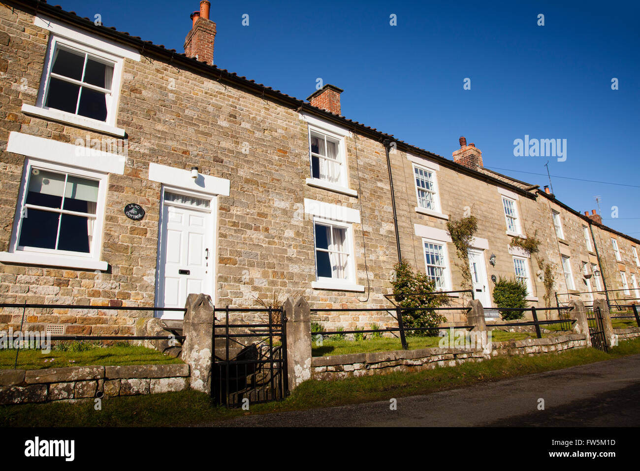 Row of country houses in sunshine Stock Photo - Alamy