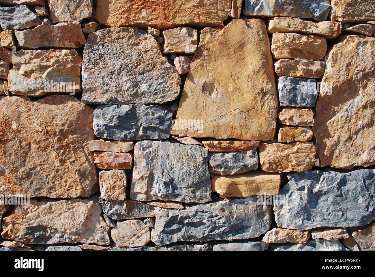 Close up of a multi coloured dry stone wall at Hora on the Greek island ...