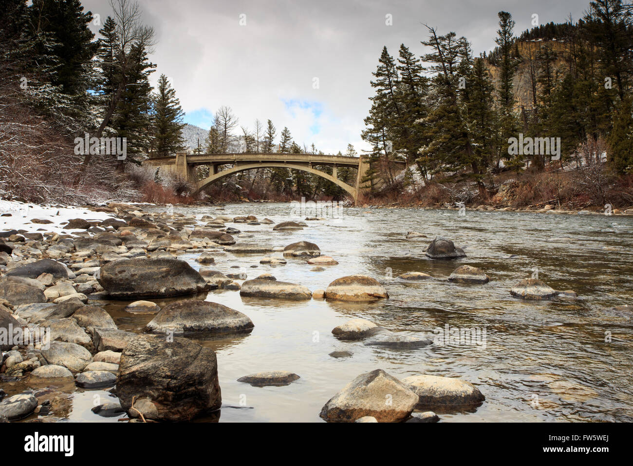 Old bridge going across the flowing river Stock Photo - Alamy