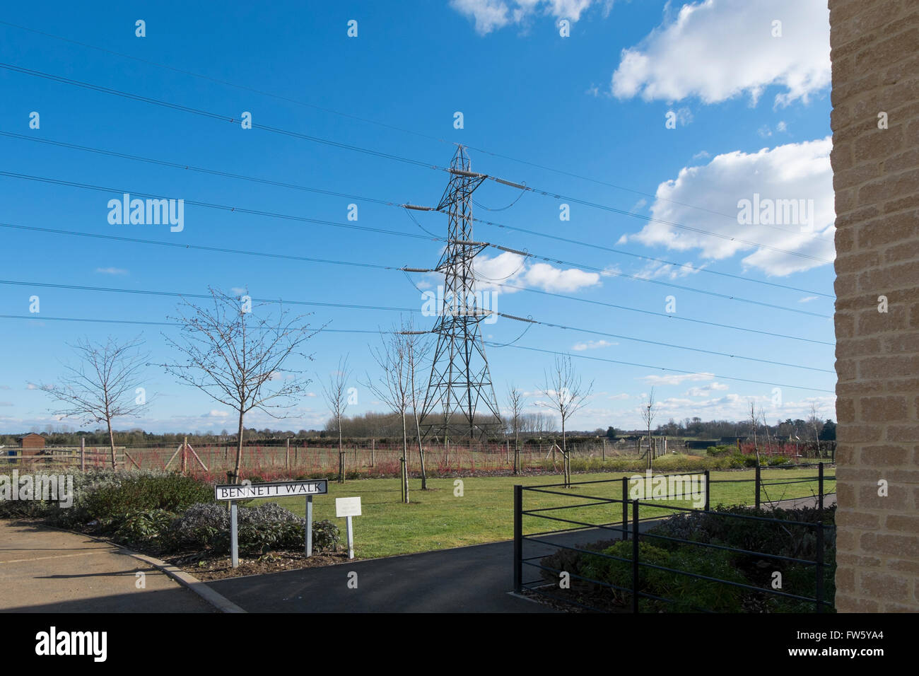Electricity pylon next to a new housing development on the outskirts of ...