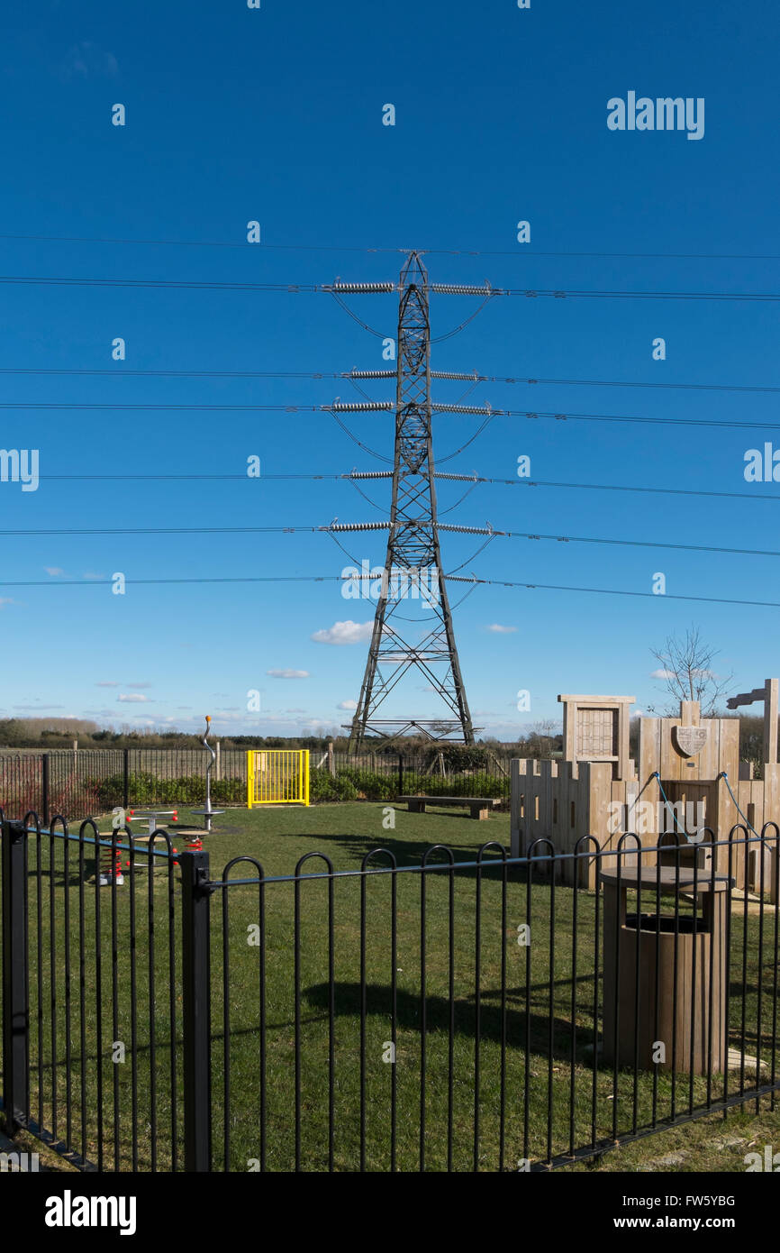 Electricity pylon next to a new housing development on the outskirts of ...