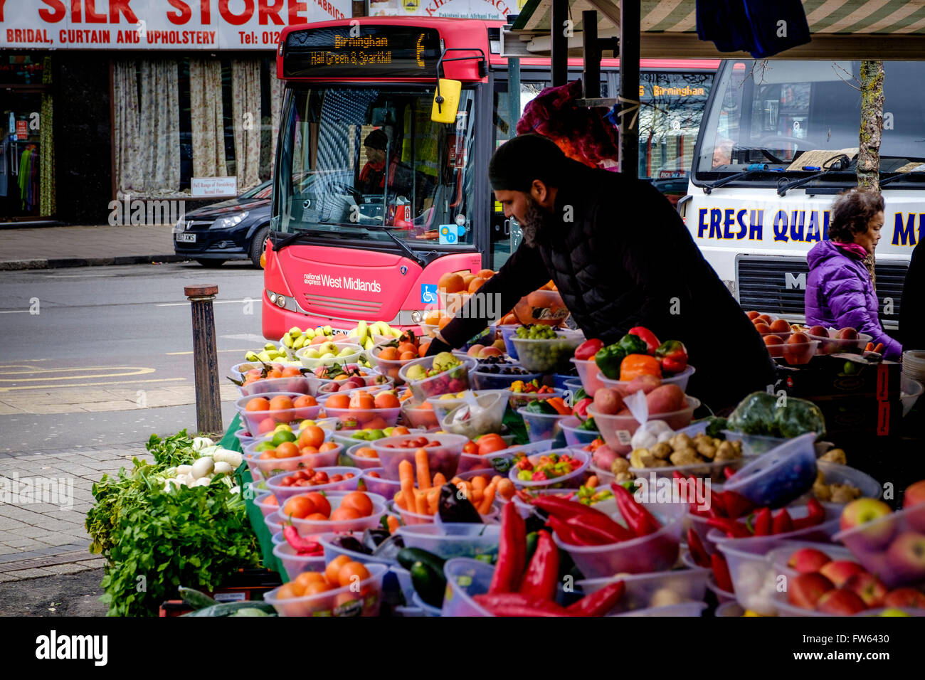 Stall holder selling vegetables from a stall in the Bullring Market in ...